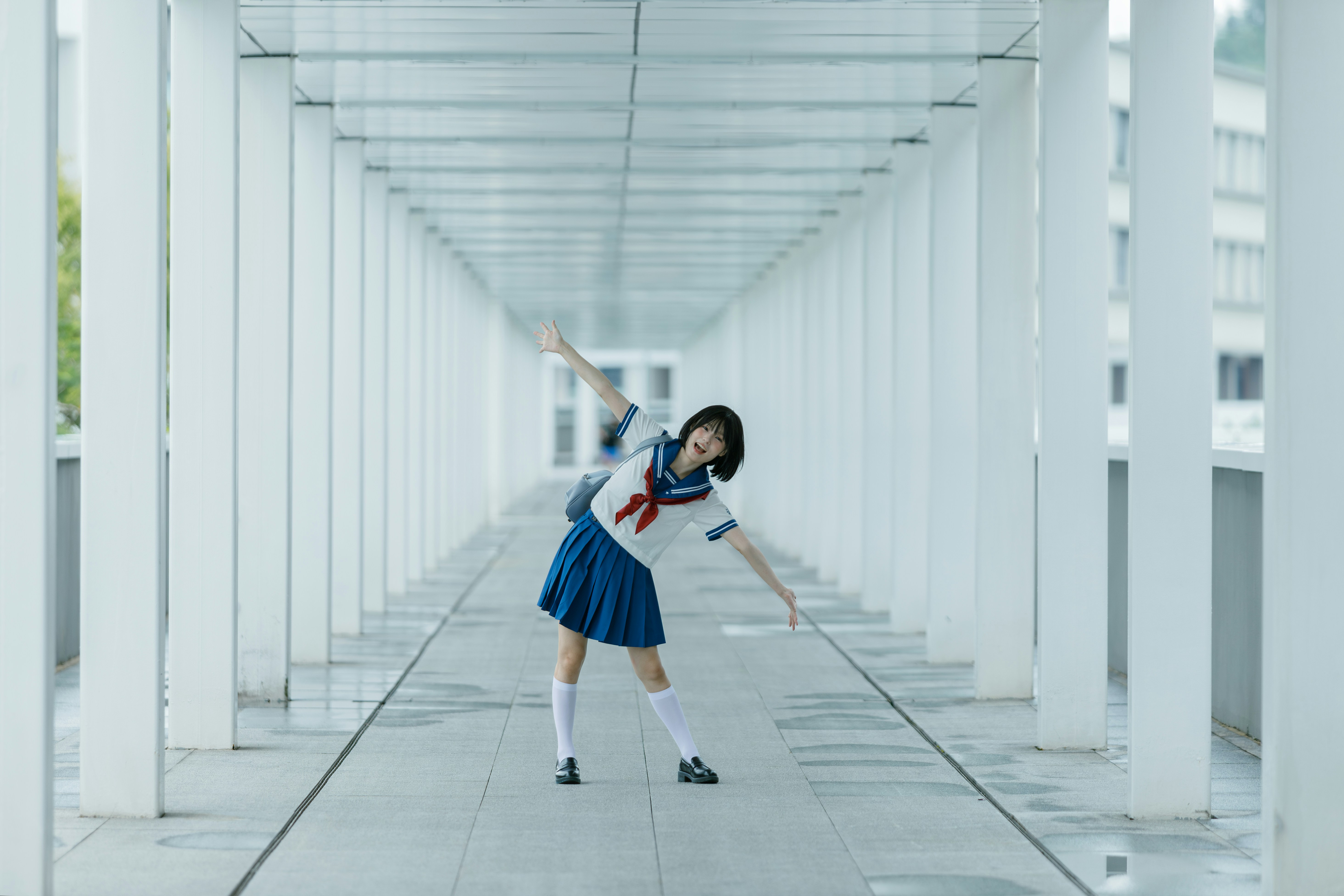 A schoolgirl poses on a white walkway. photo – Free Girl Image on Unsplash