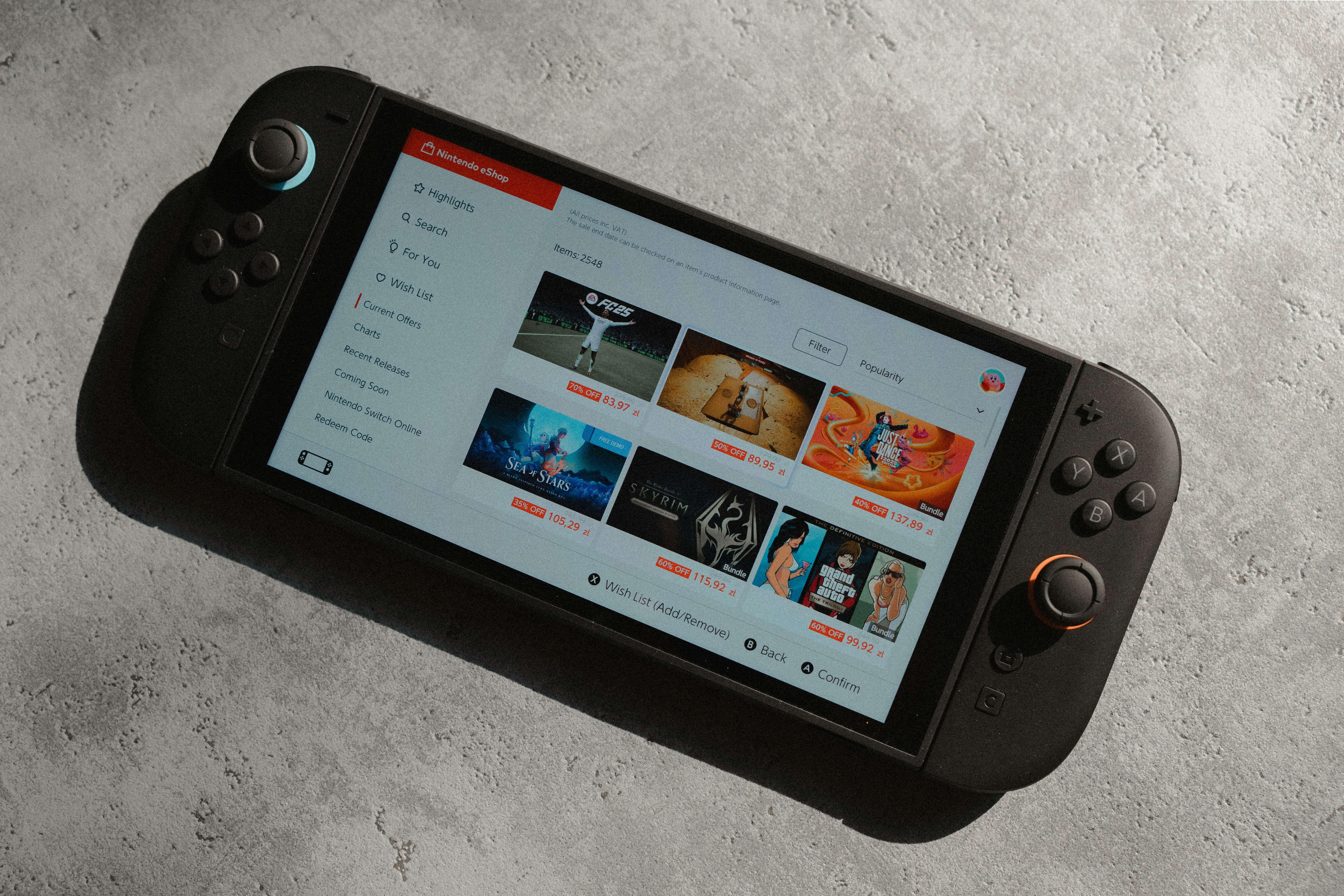 Handheld gaming console displaying a video streaming service. photo ...