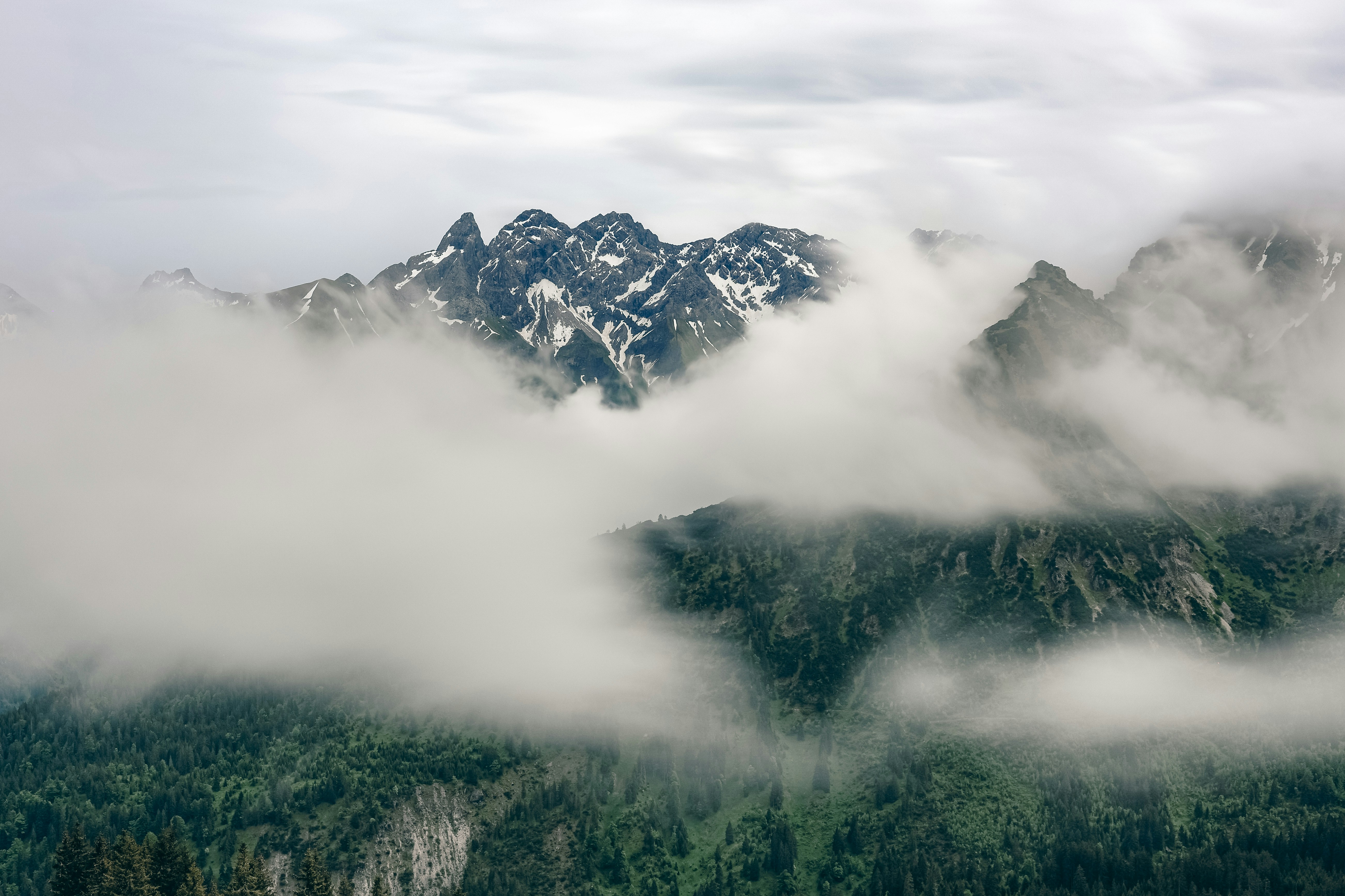 Veil of Mist Over Majestic Peaks