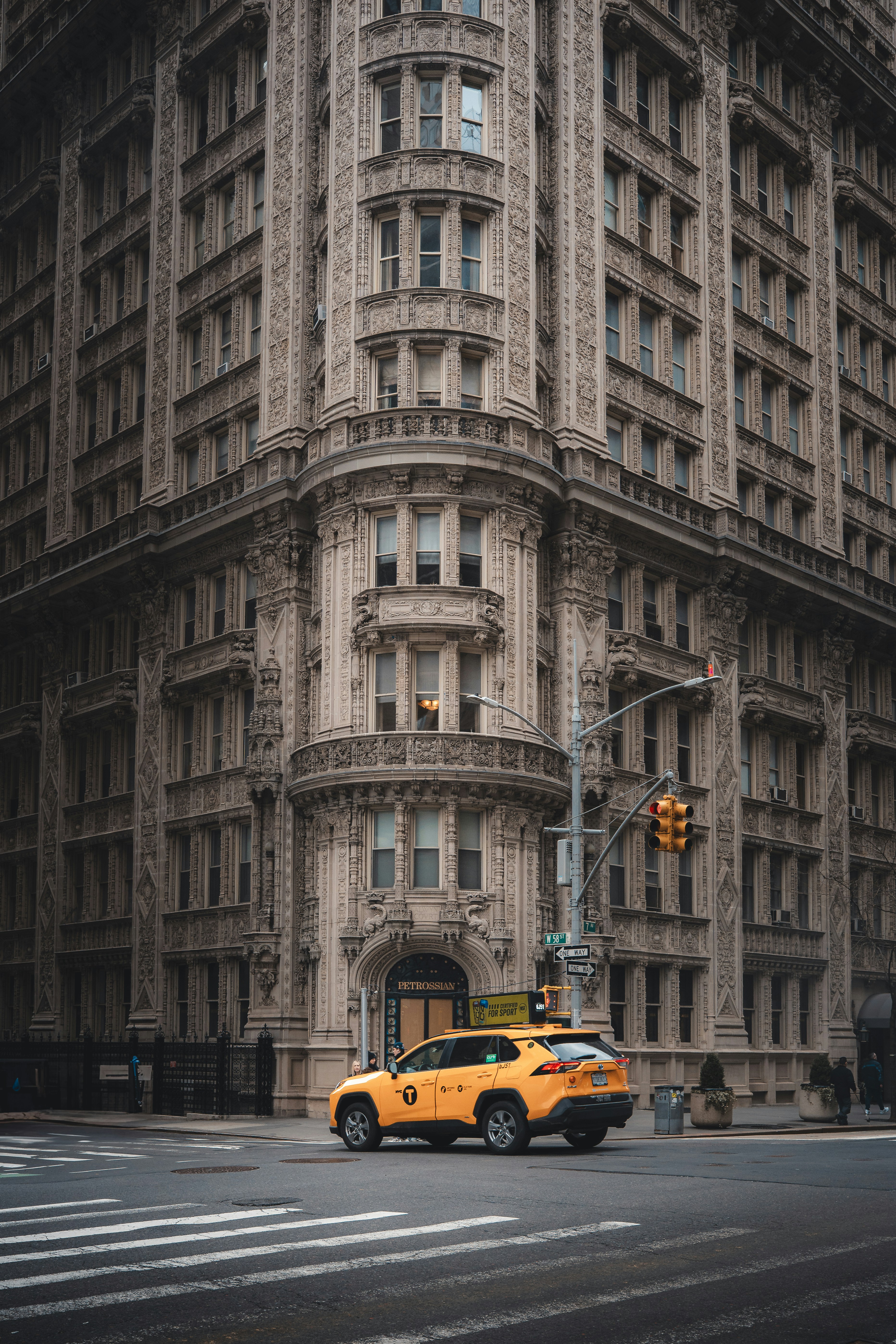 Yellow Taxi at the Foot of an Ornate City Corner