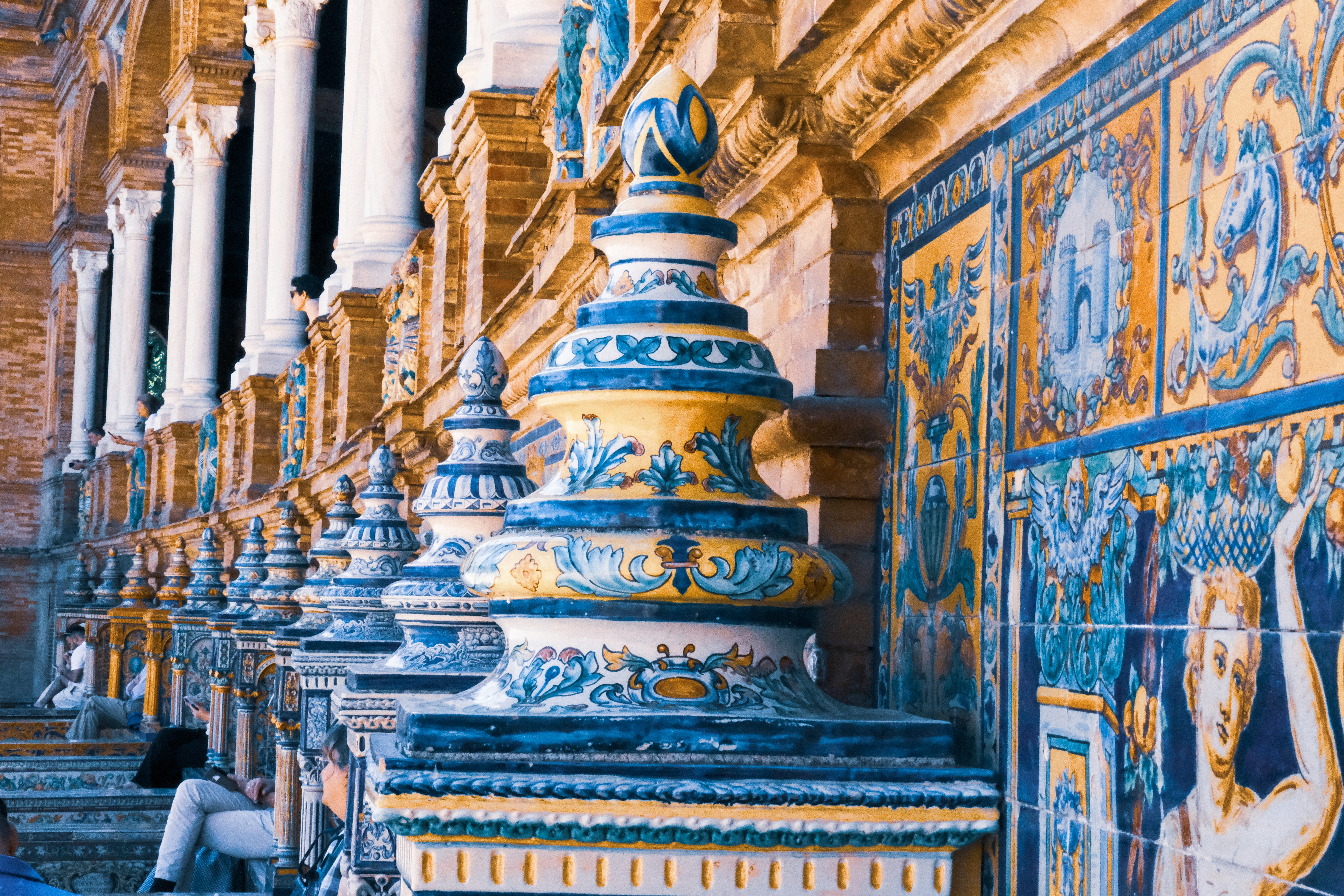 Intricate ceramic tiles and decorative pillars line the architectural façade, showcasing vibrant colors and detailed artistry.