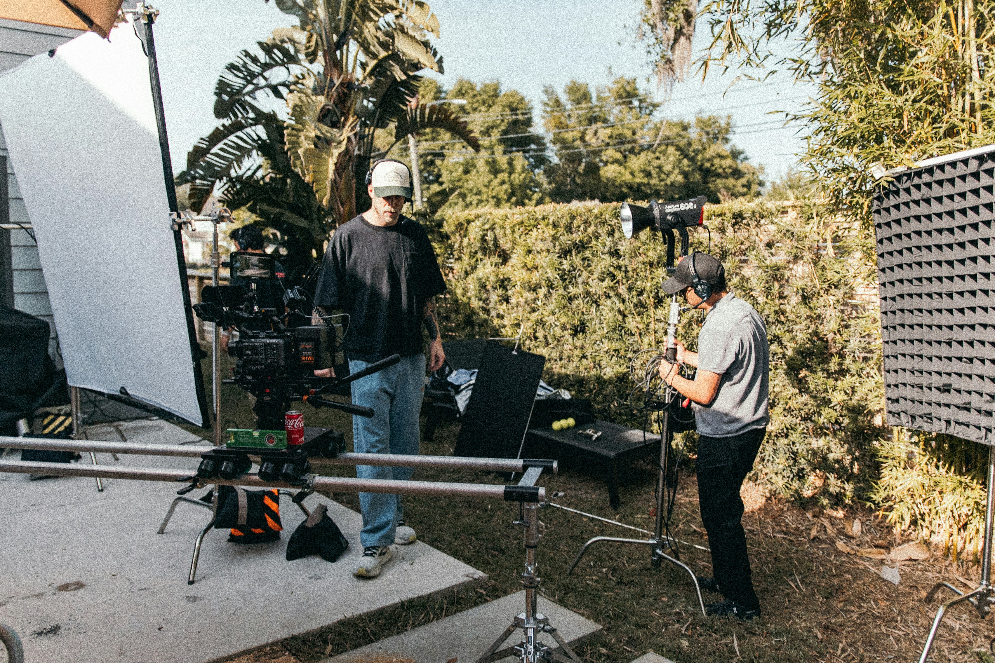 Crew members are preparing for a film shoot outdoors.
