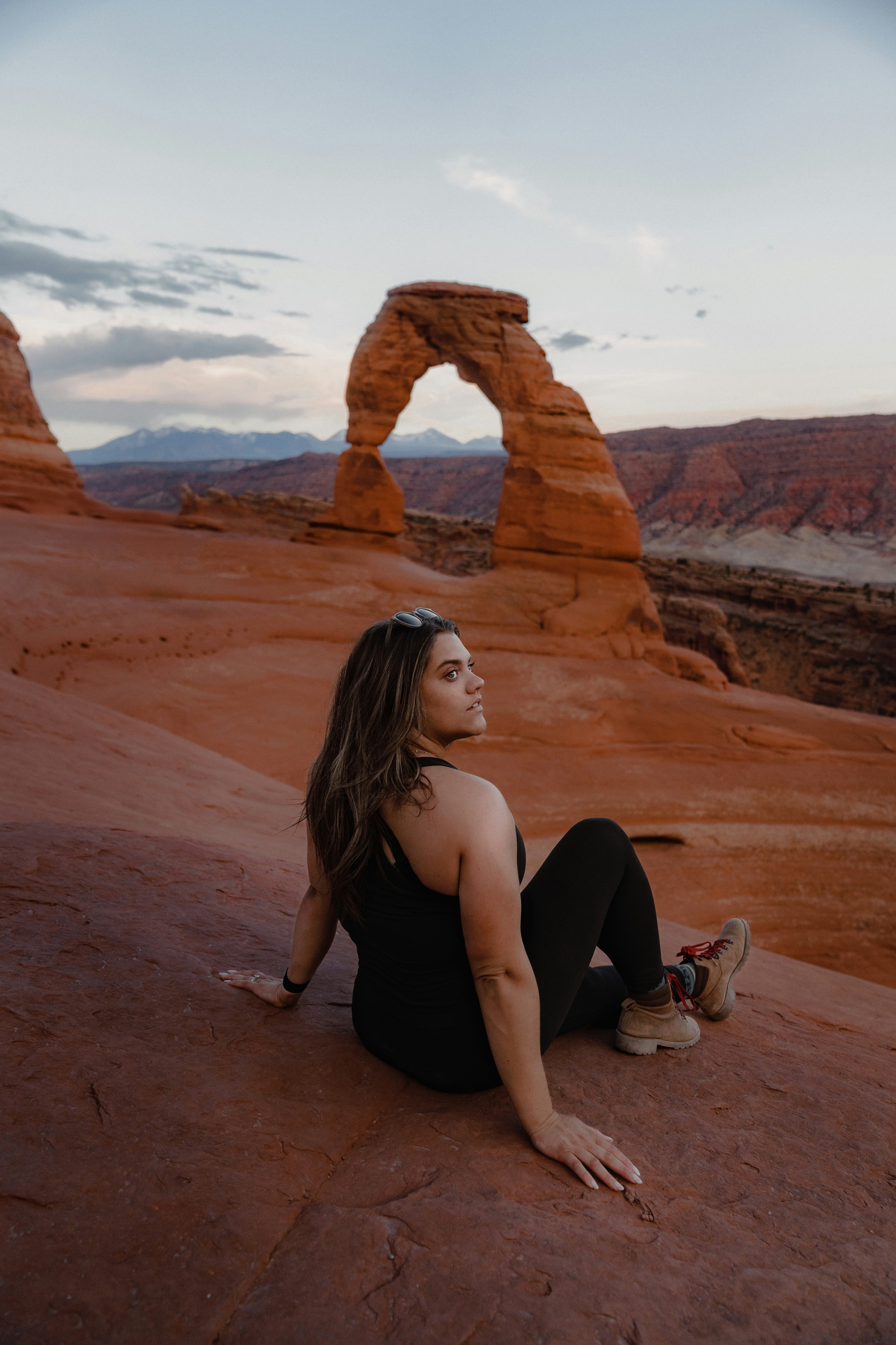 Woman poses near delicate arch in utah. photo – Free Woman Image on ...