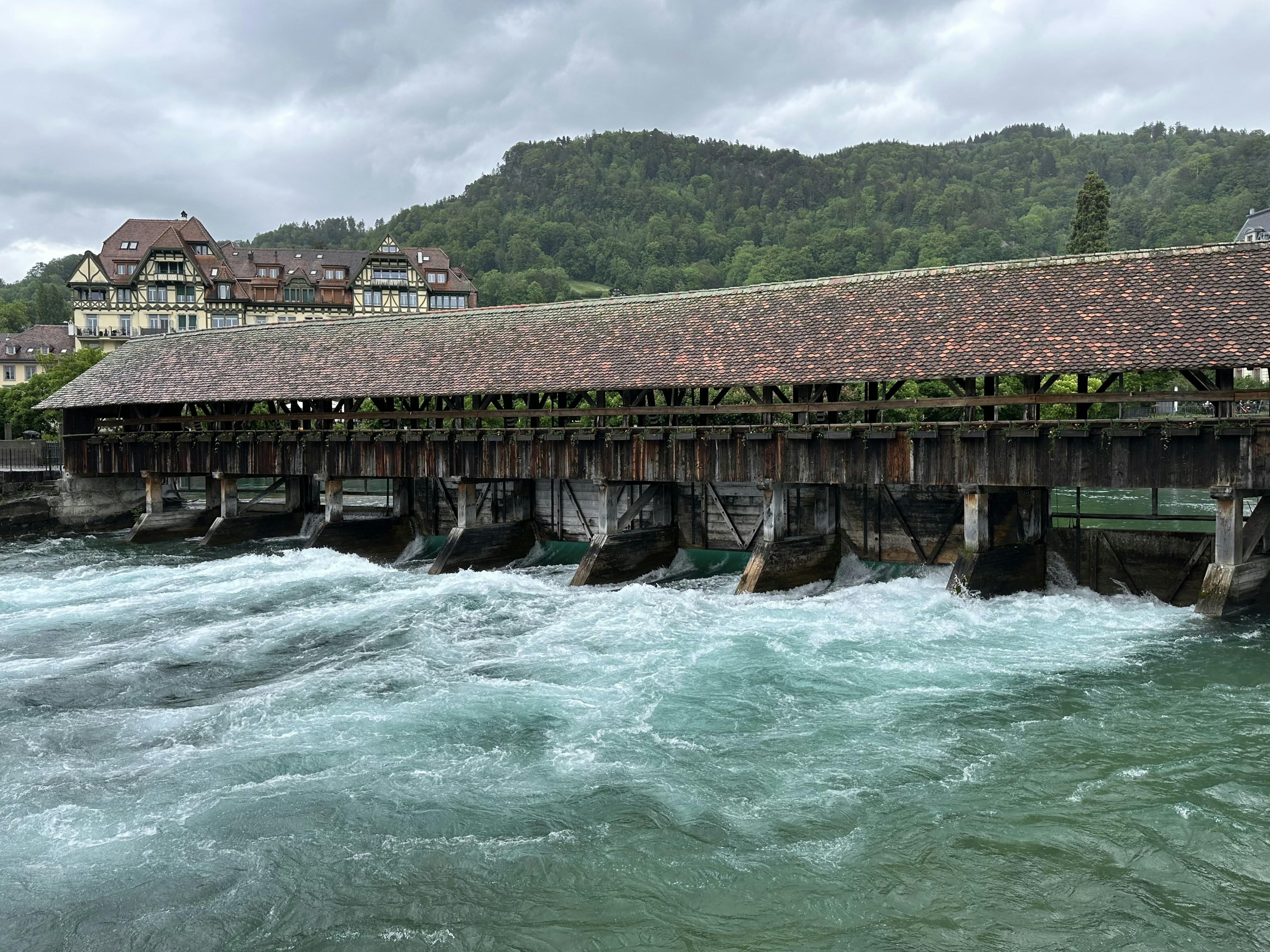 Timber Legacy: The Historic Bridge Over Turbulent Waters