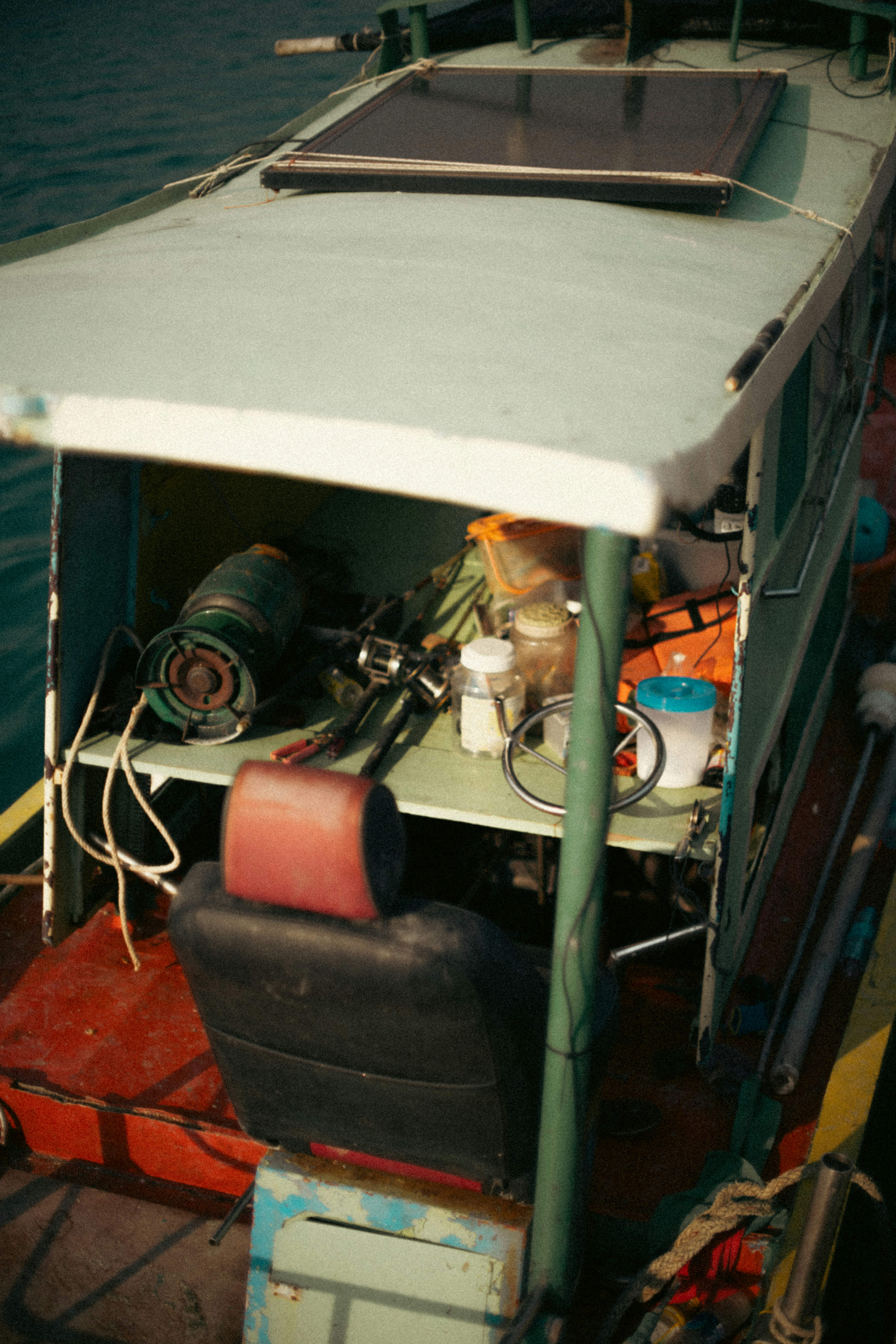A boat interior with equipment and a seat.