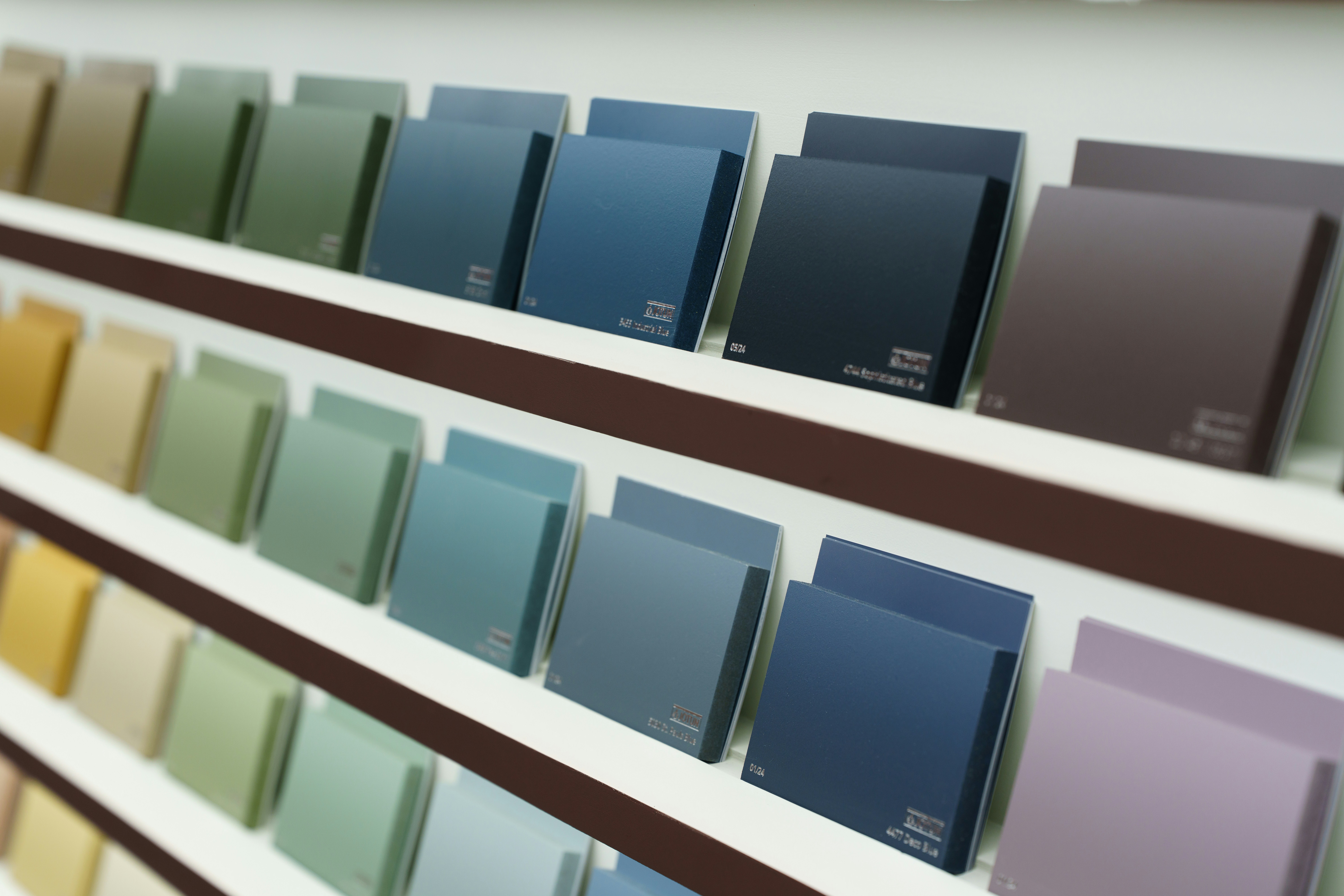 Paint color swatches are displayed on a shelf. photo – Free Business ...