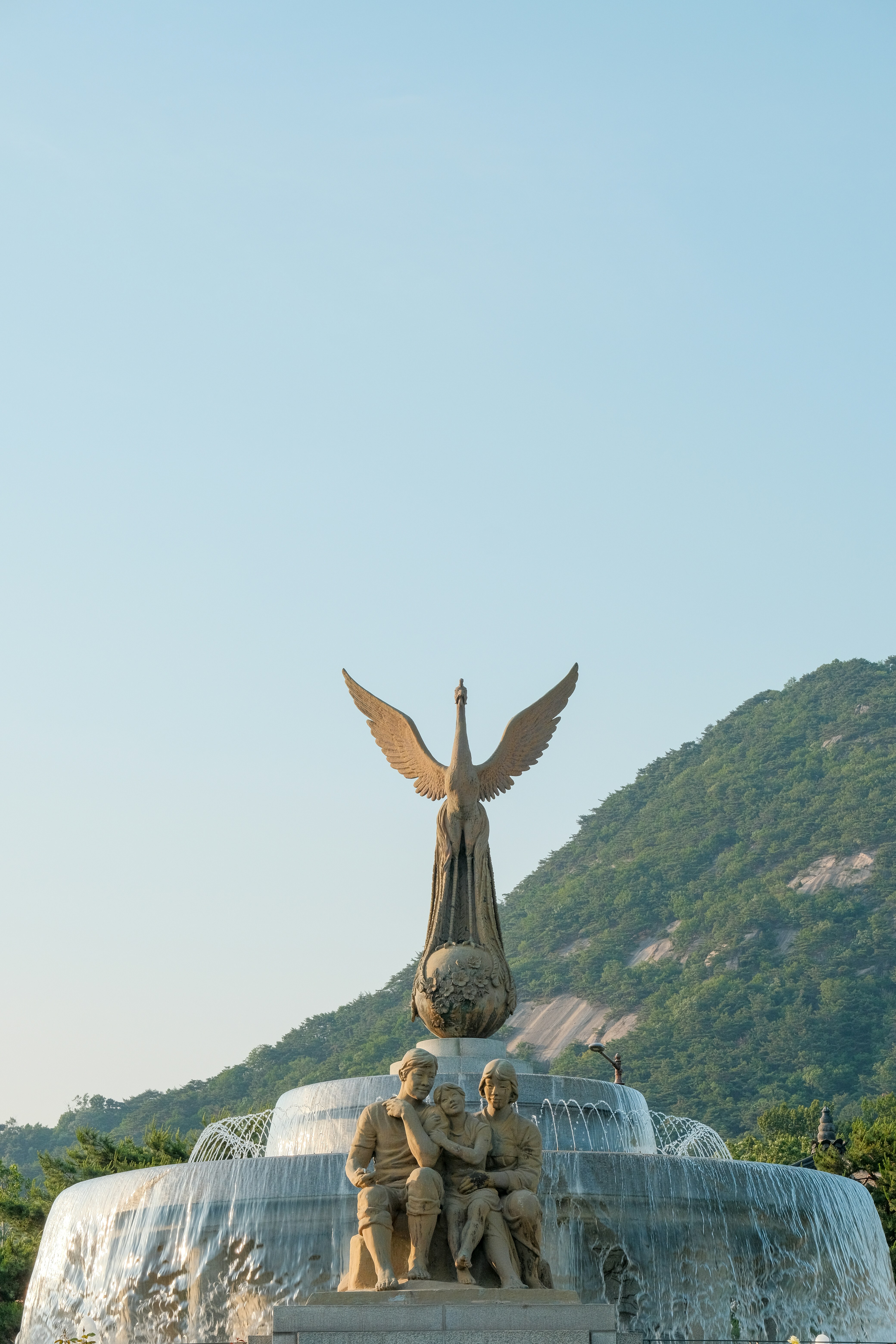 Winged Sentinel Over Cascading Fountain at the Hillside