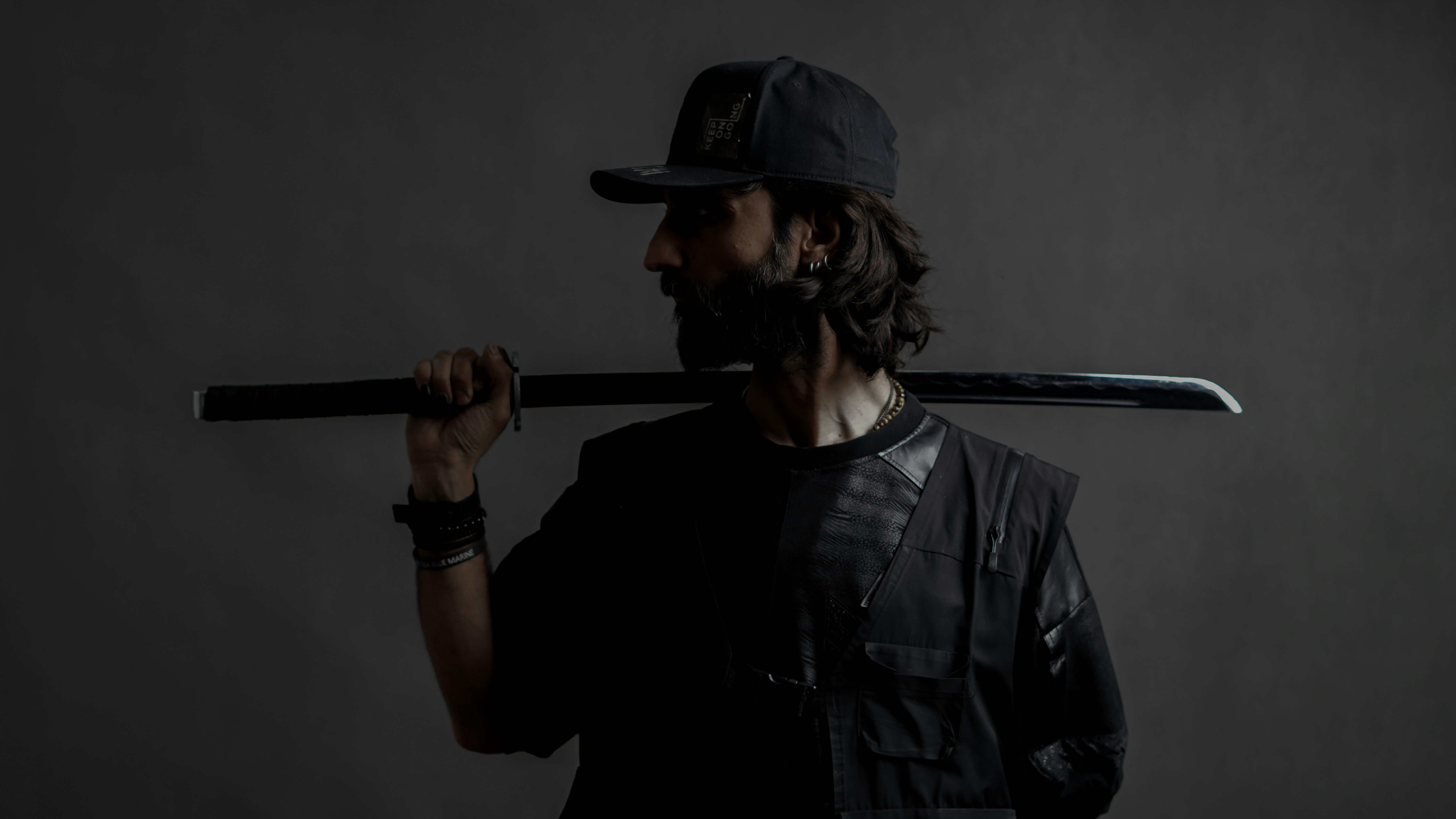 Man in black holds a sword over his shoulder. photo – Free Image on ...