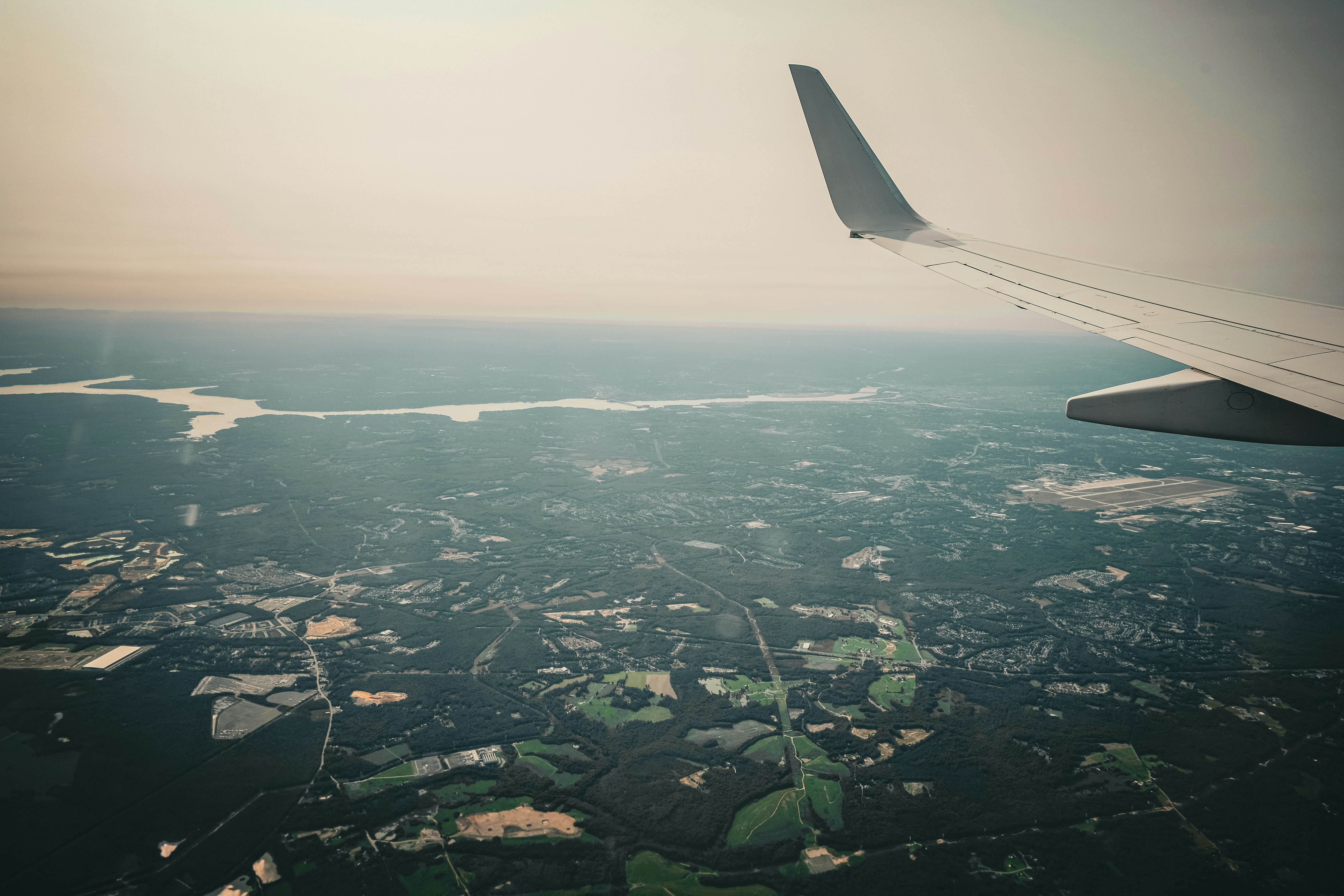 Airplane wing view of the earth below.