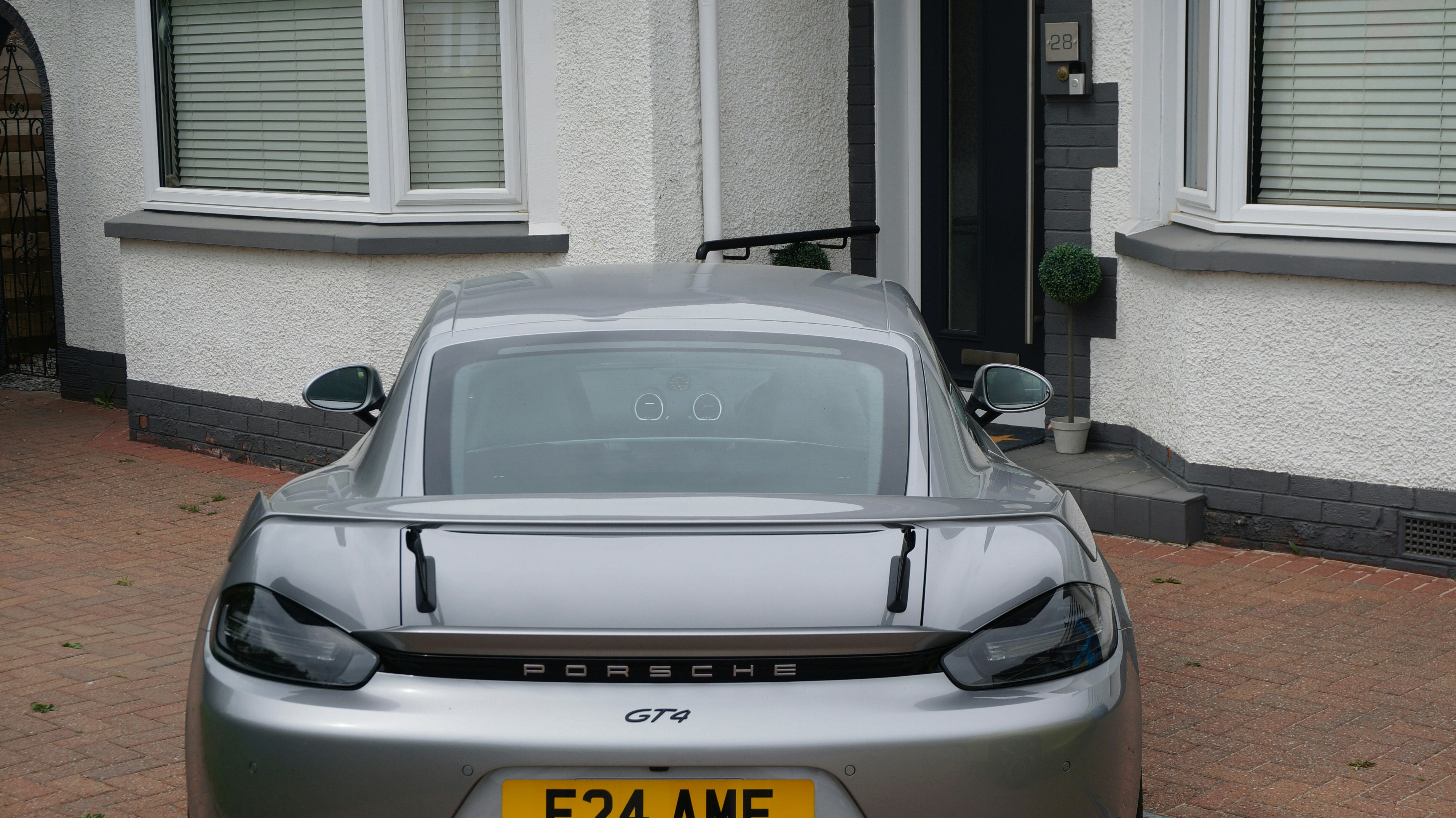 Midnight Silver Porsche  GT4 Hatchback Back View in Driveway