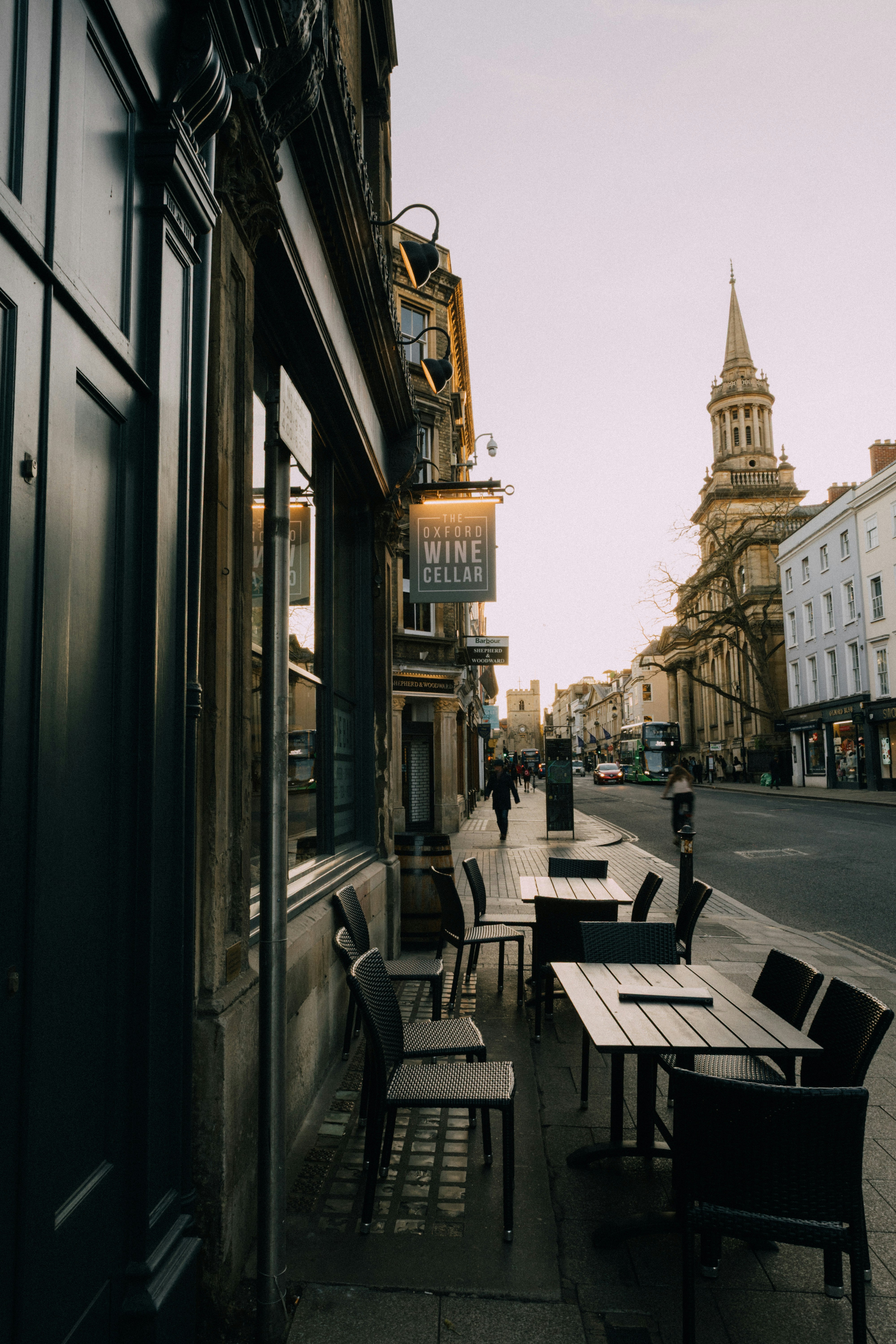 A wine cellar with outdoor seating lines a street.