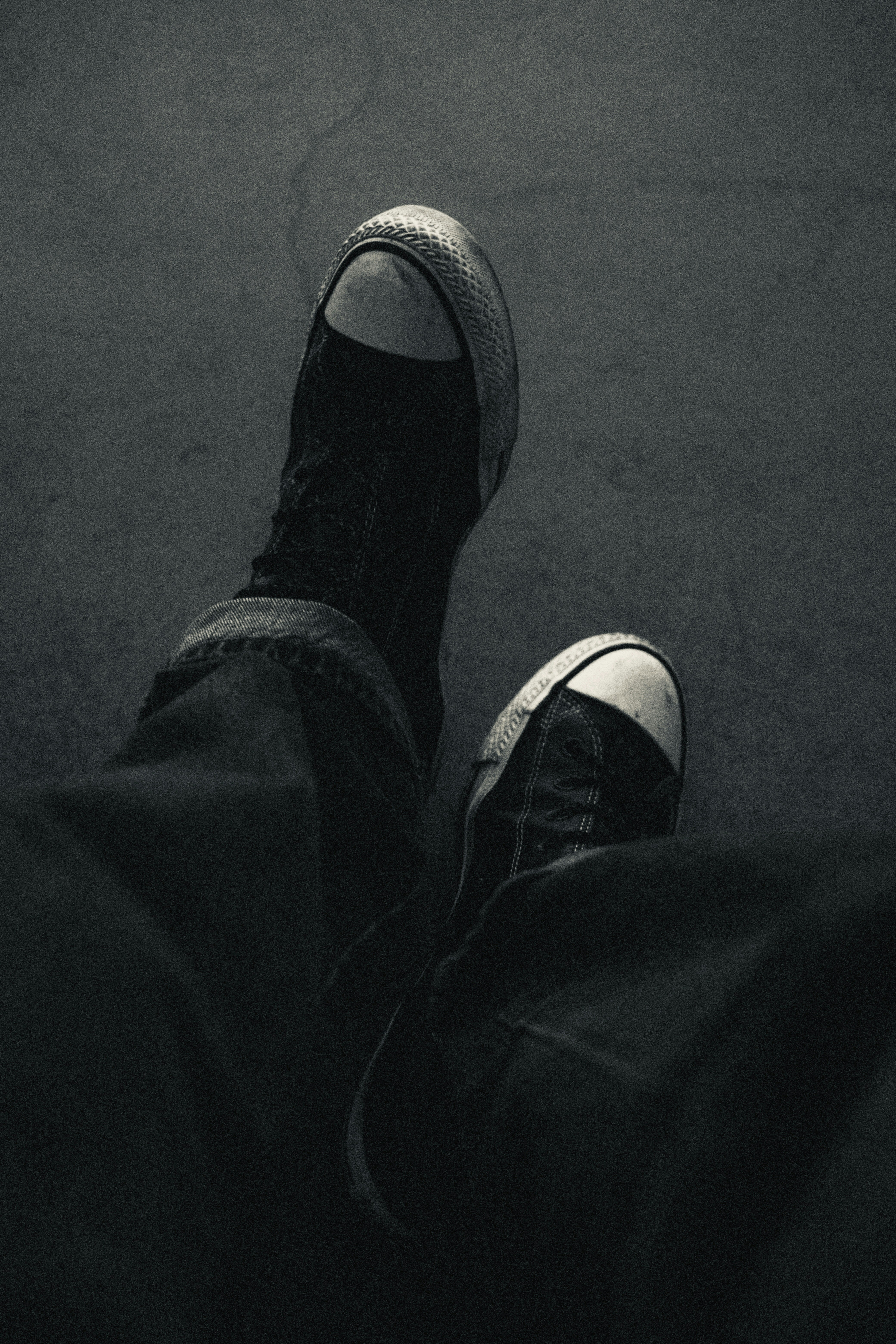 Converse | Sneakers and legs in a monochrome perspective.