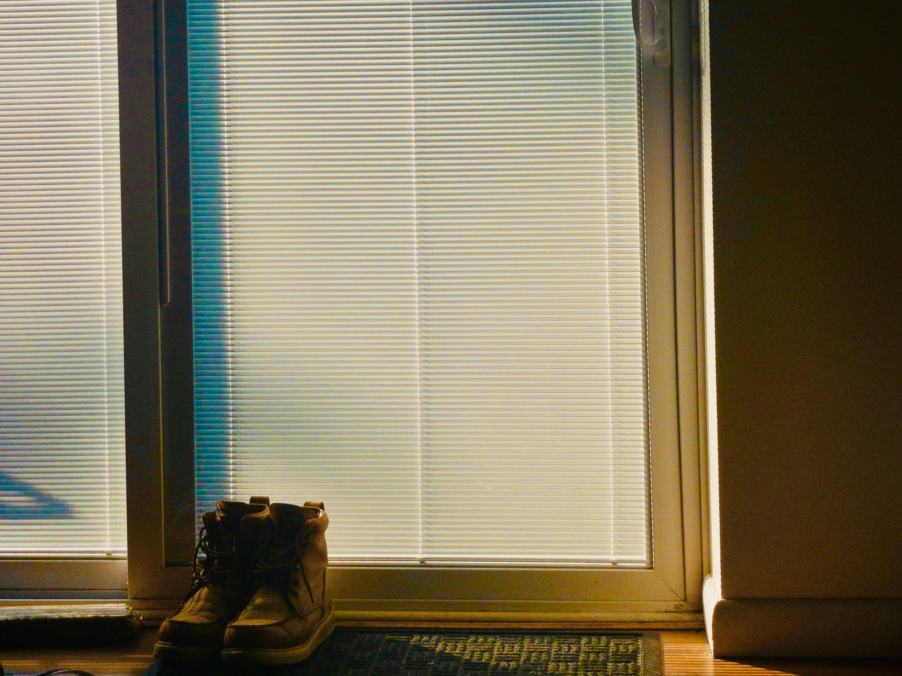 Boots at Dawn: Quiet Light by the Window Blinds