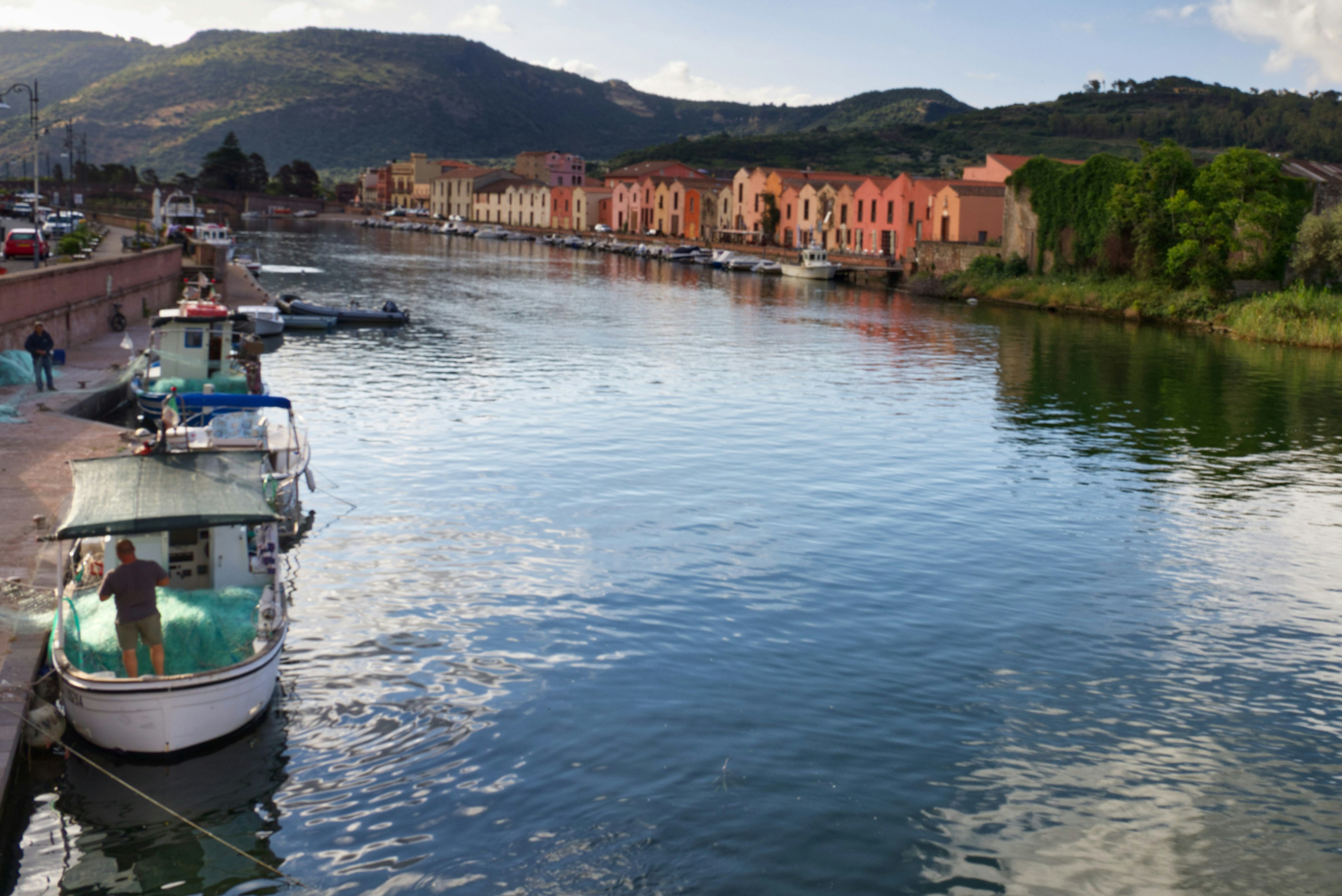 Pastel Canalfront: Boats, Reflections, and a Sunlit Riverside Town