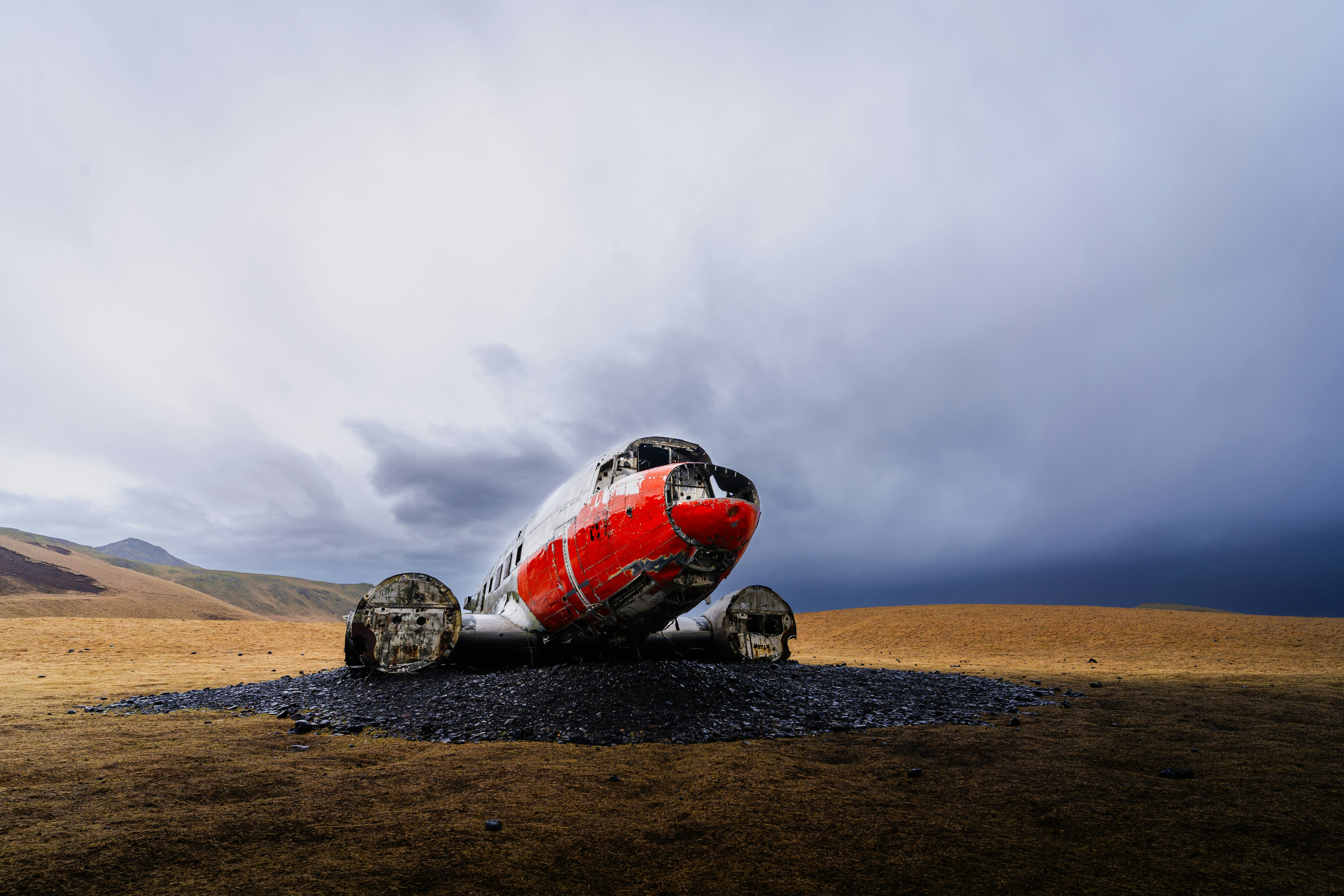 Wrecked Airliner Resting on Charred Ground Under A Heavy Sky