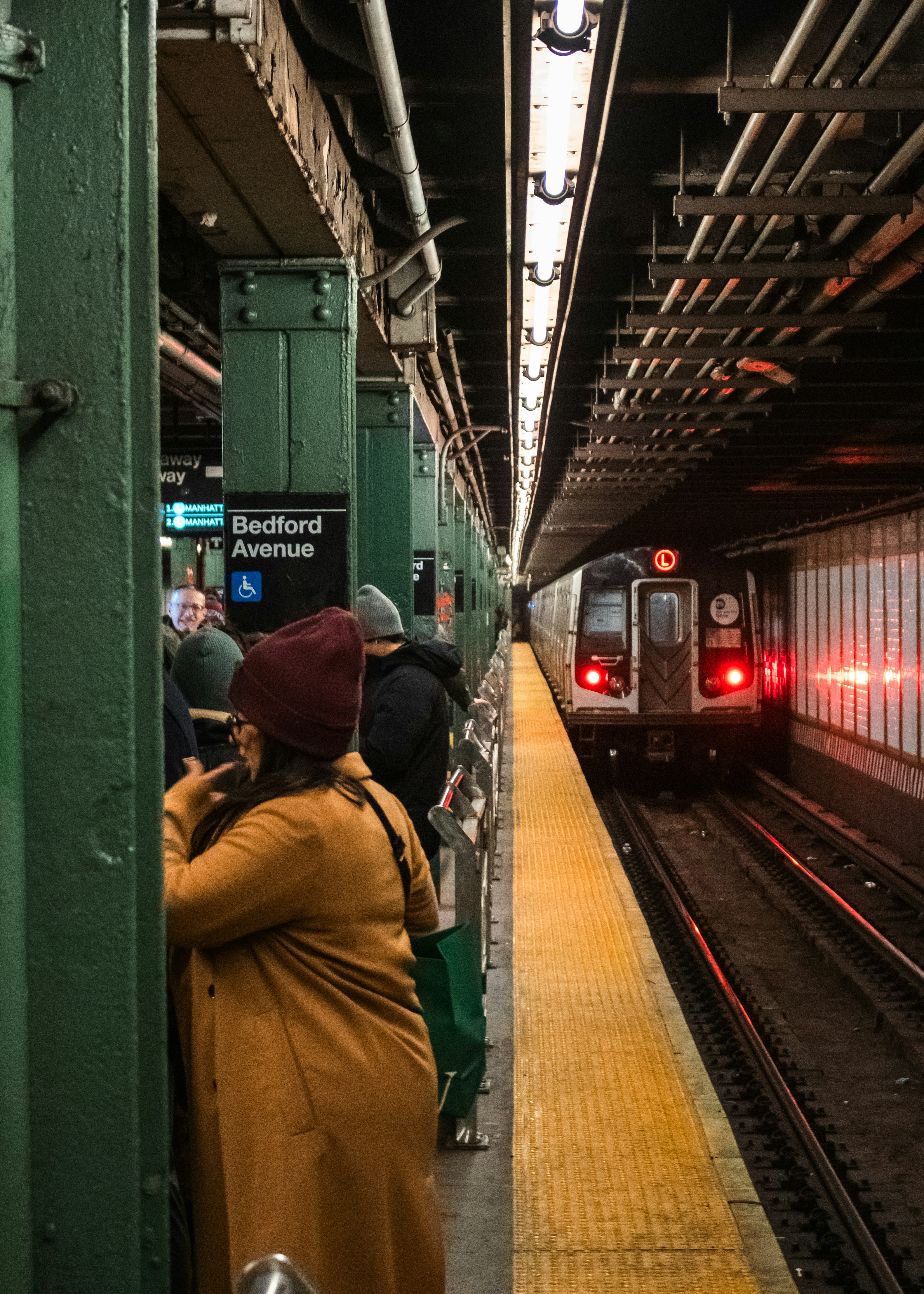 Platform Pulse: commuters wait as the train glides into New York–style underground light
