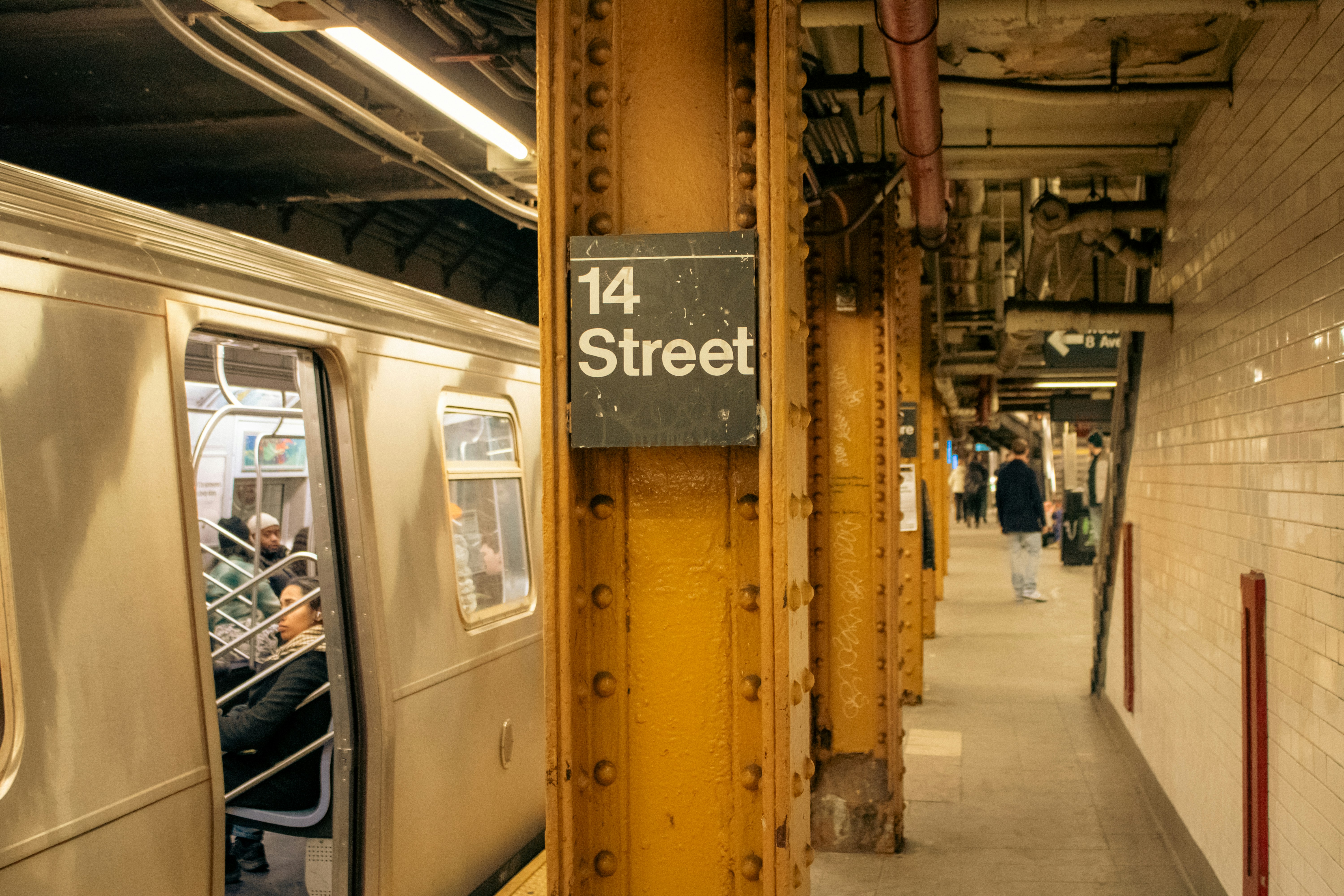 14 Street Station: Platform Perspective with a Waiting Train and Weathered Steel Columns