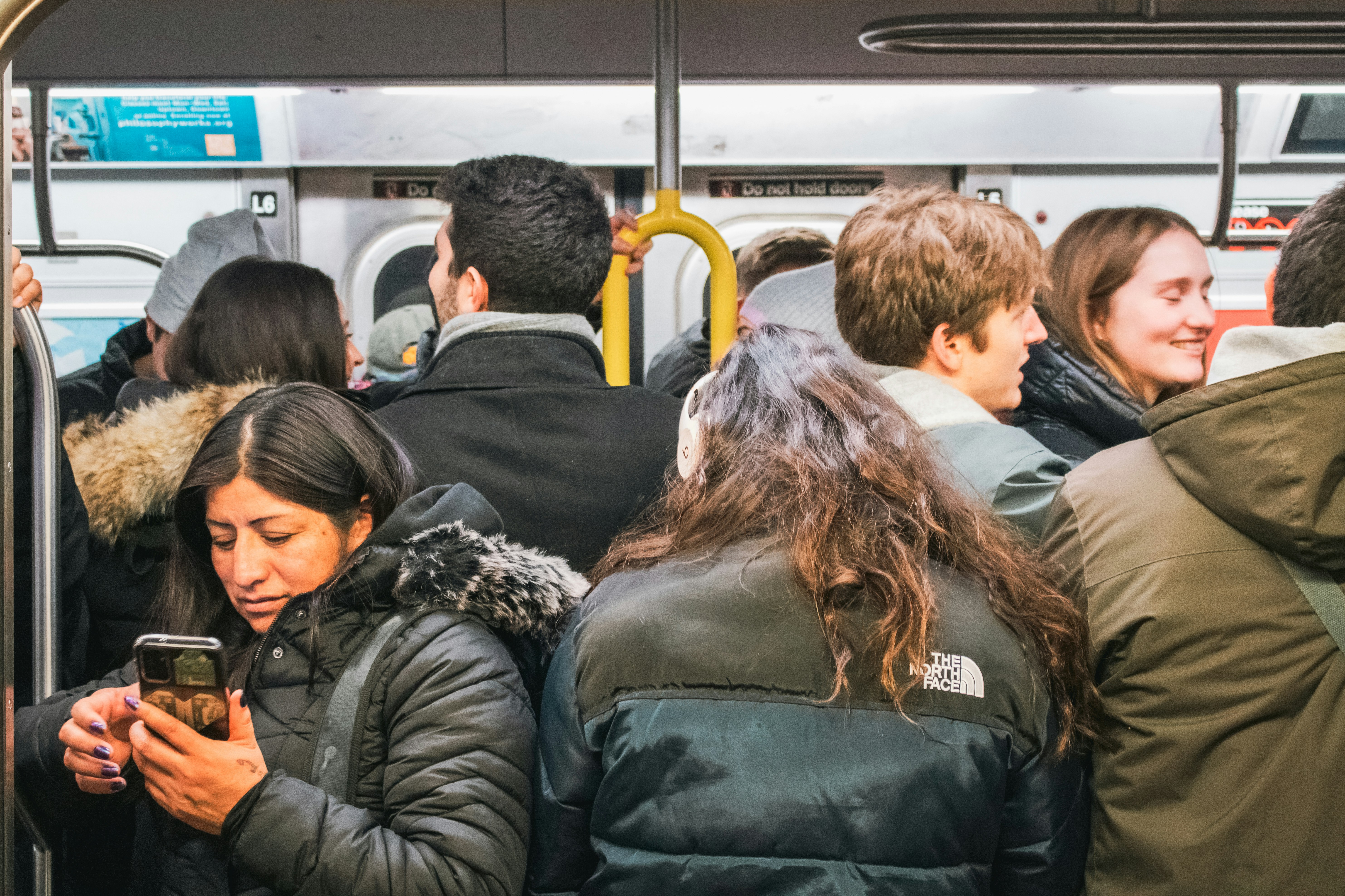 People crowd inside a busy subway train car. photo – Free Travel Image ...