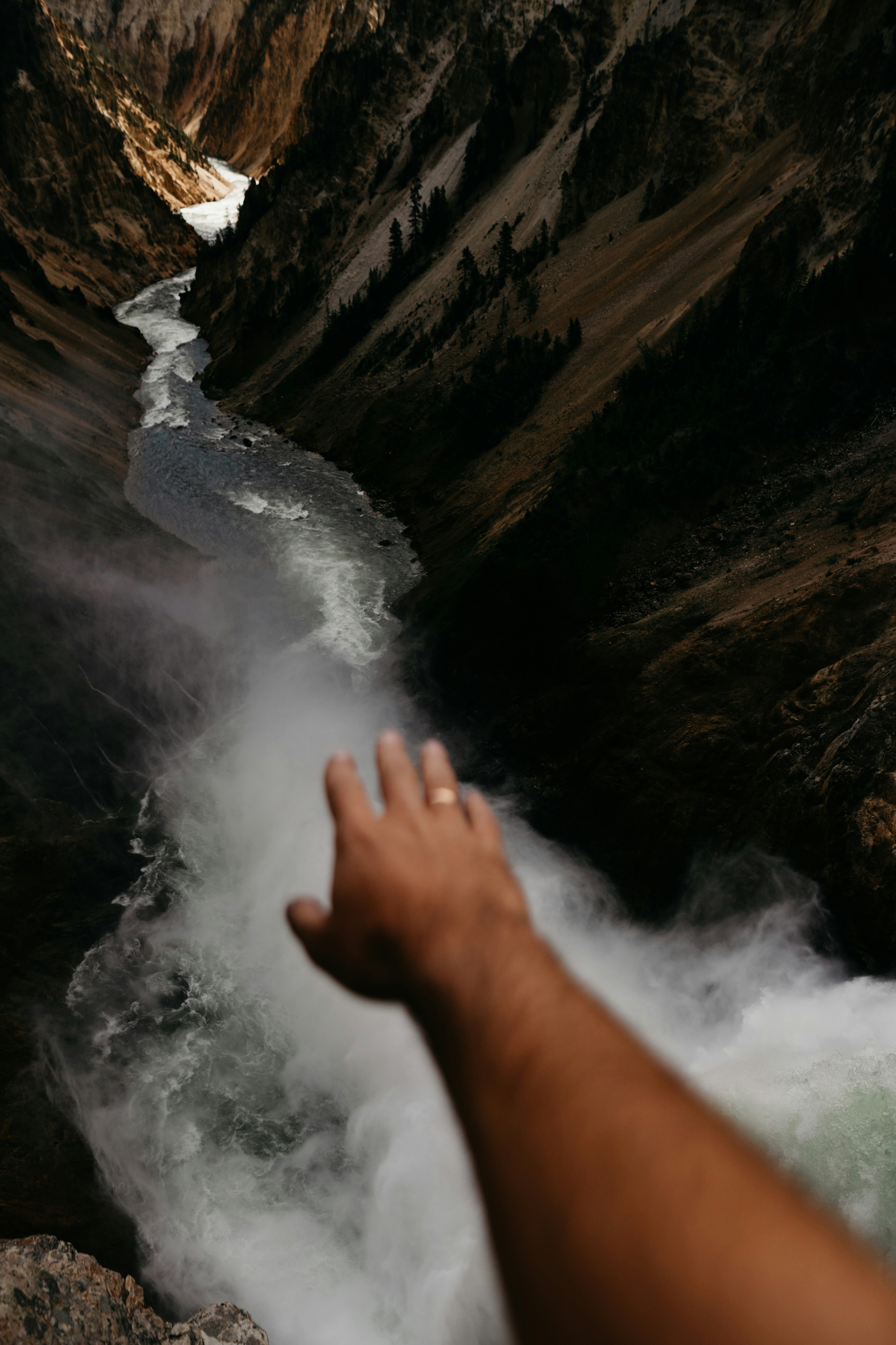 Hand reaches toward a majestic canyon and river. photo – Free Waterfall ...