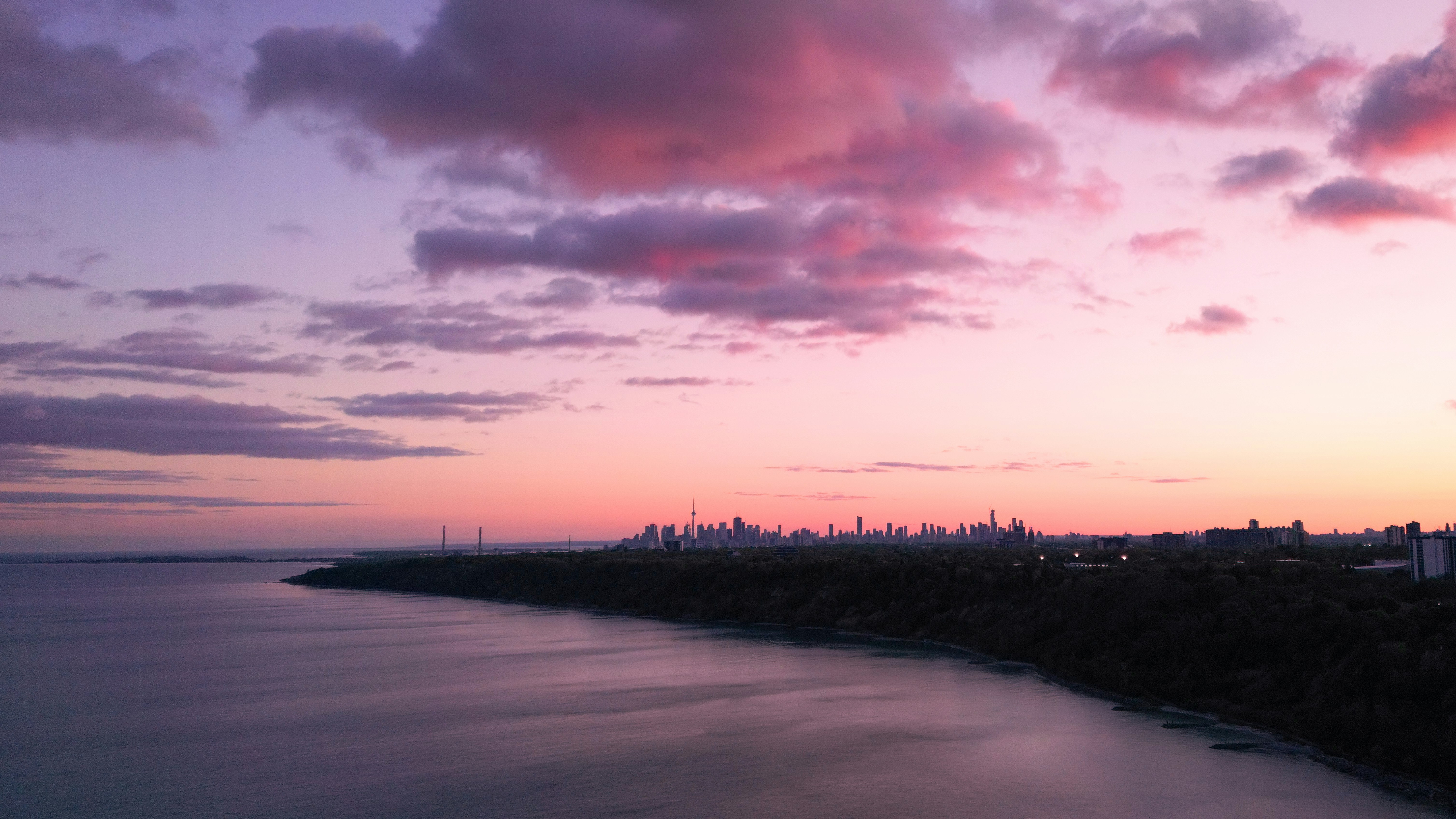 Pastel Dusk Over the Quiet Coast: City Silhouette at Sunset