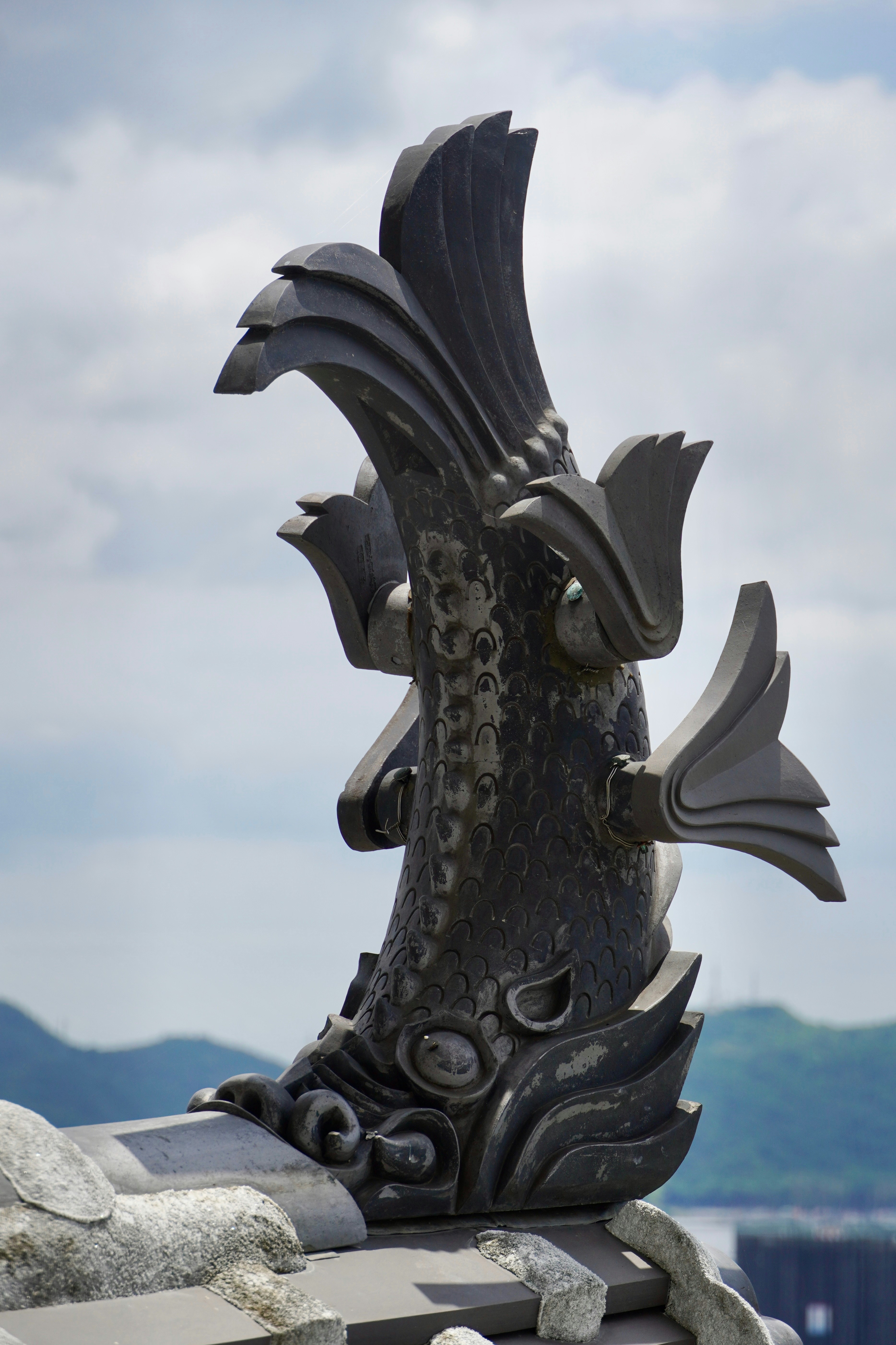 Dragon Guardian: Weathered Steel on a Rooftop Ridge