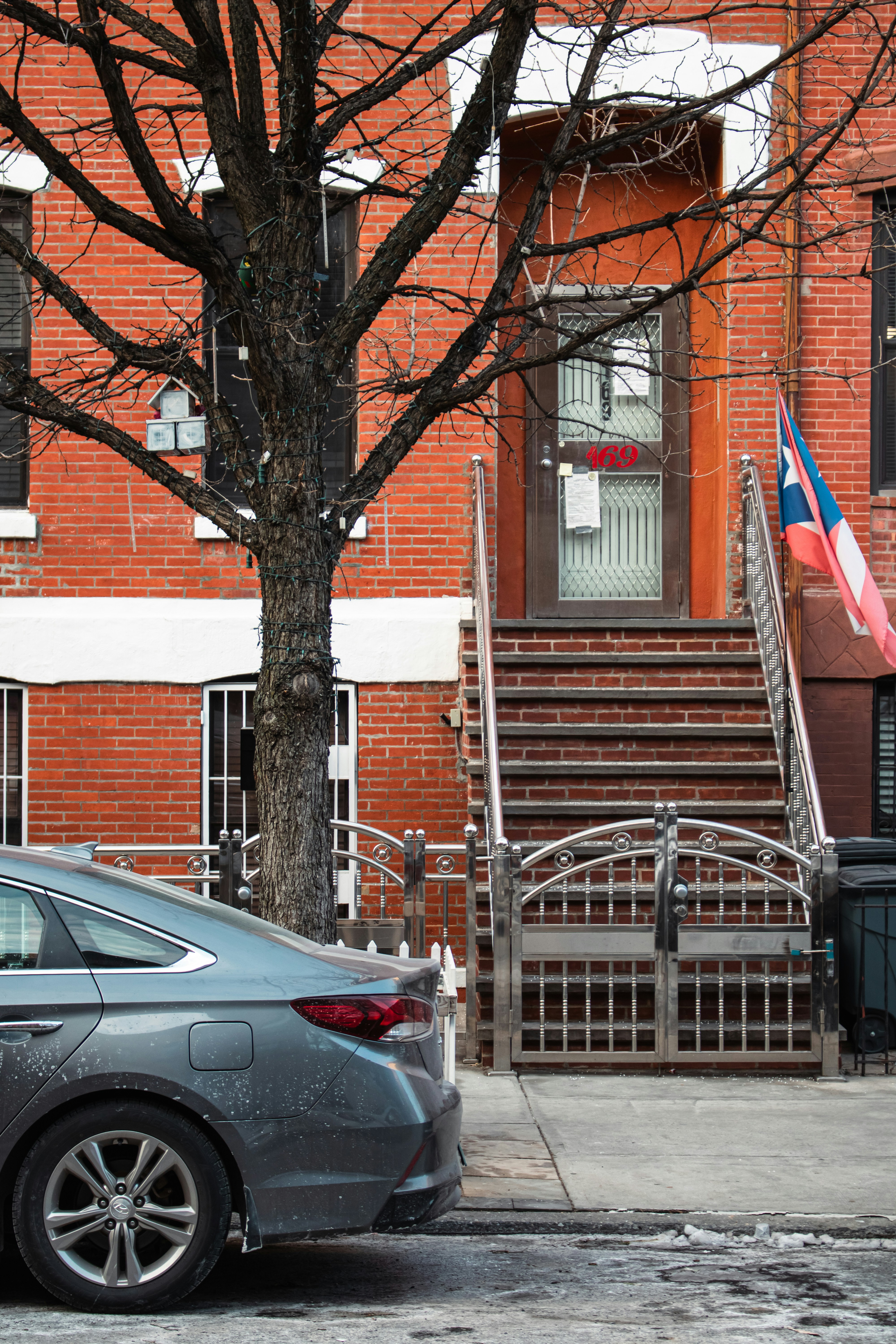 Brick Brownstone Stairway to a Flag-Rimmed Entrance