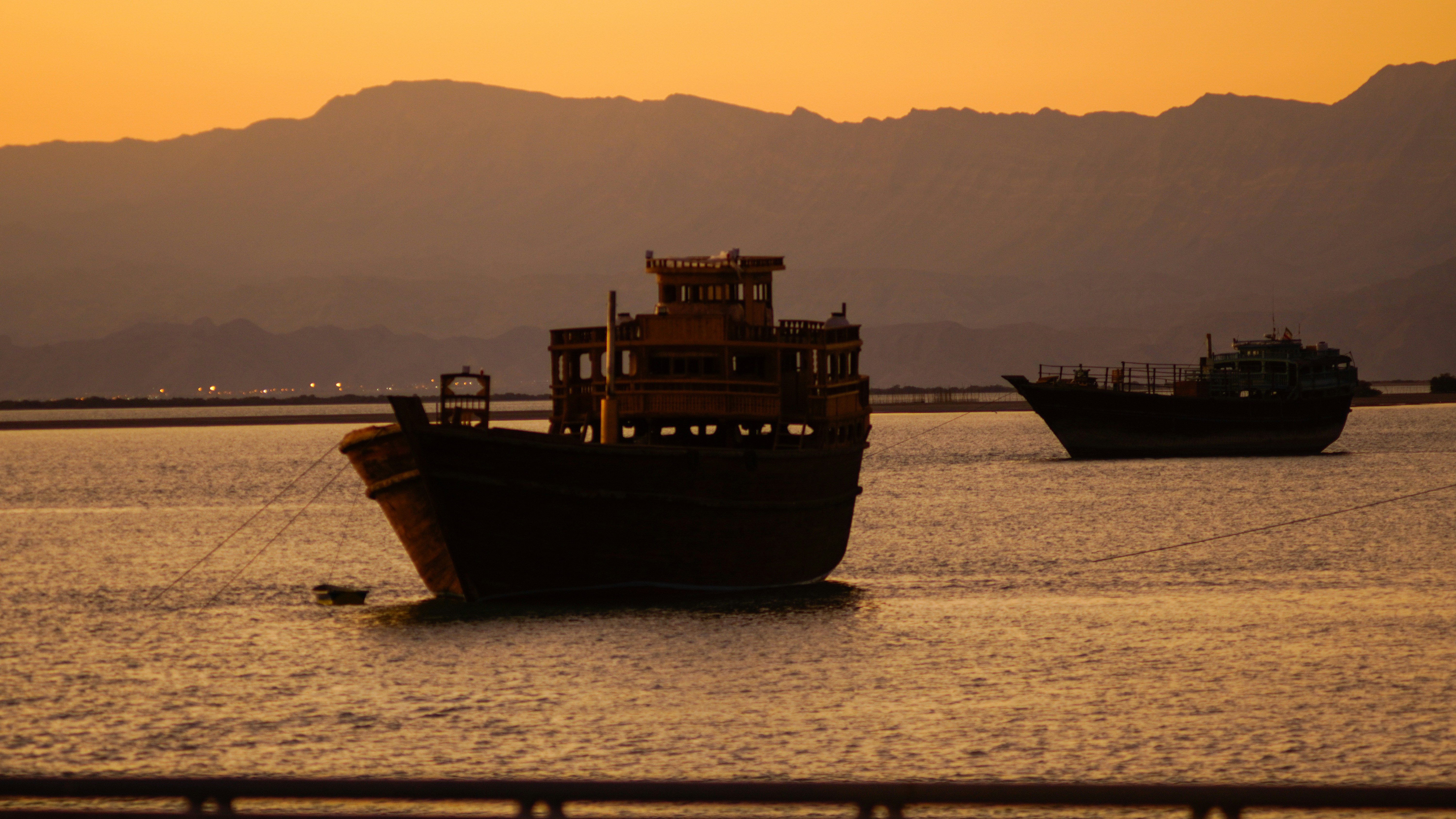 Harbor of Firelight: Silhouetted Vessels in Golden Hour