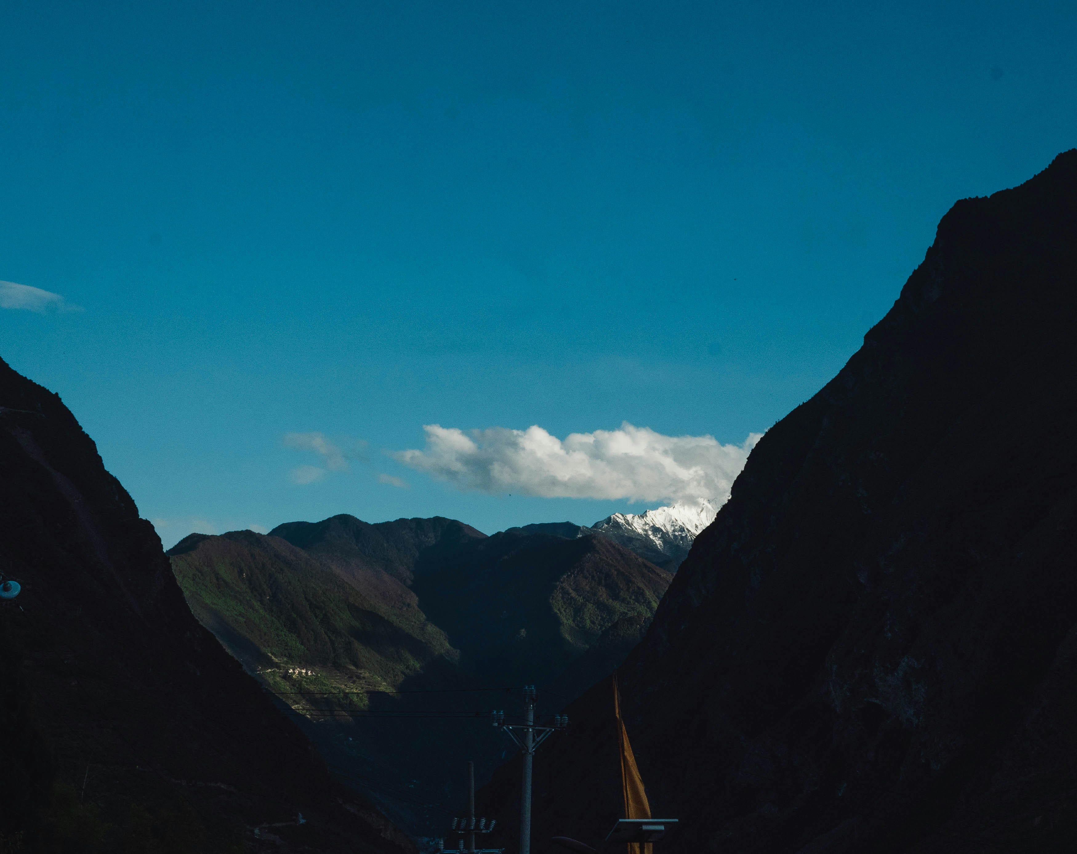 Sunlit Valley Between Shadowed Peaks
