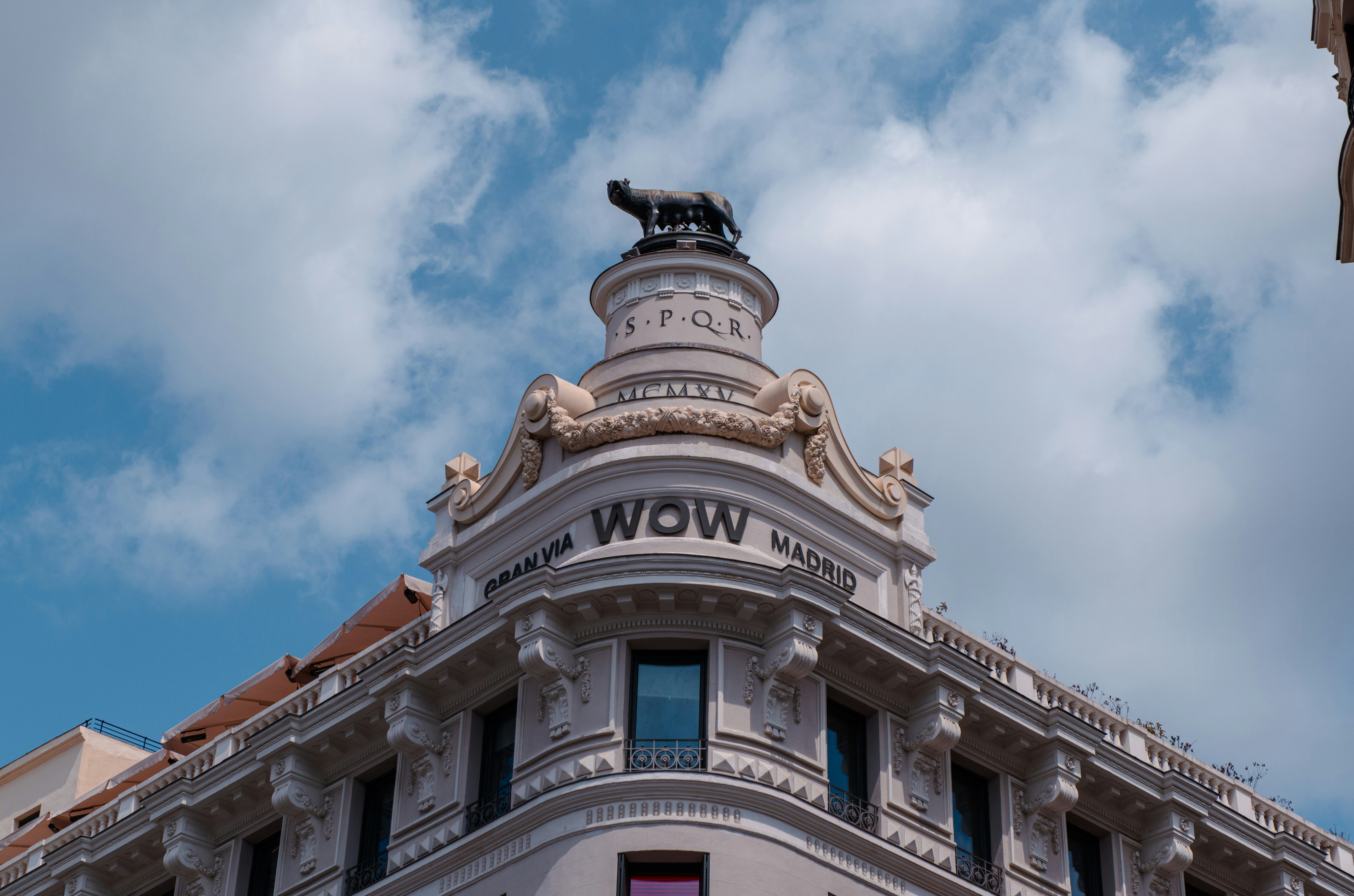 Crowned Facade: Madrid’s Ornate Corner Reaching Toward the Sky