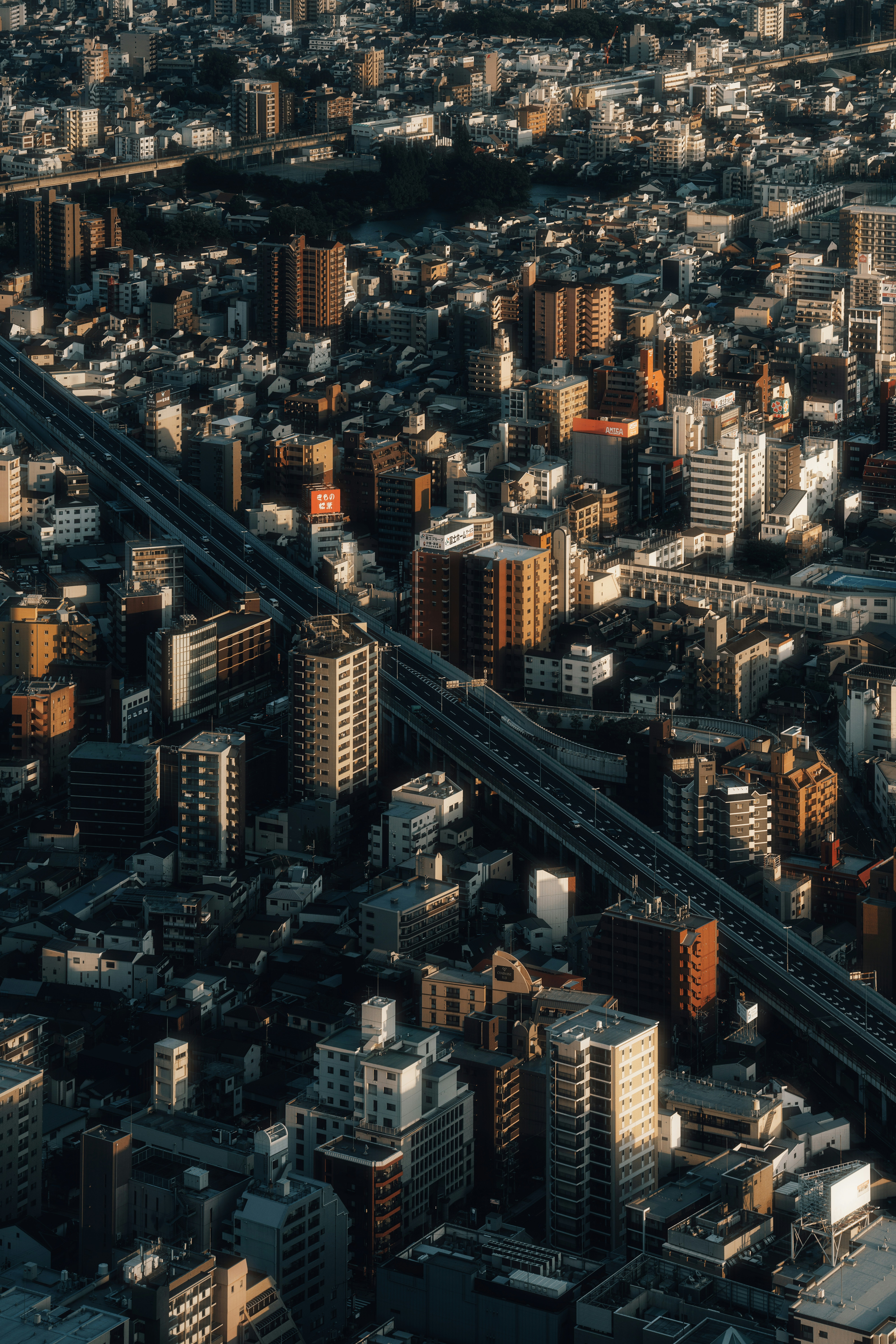 Aerial view of a densely populated city with highways.