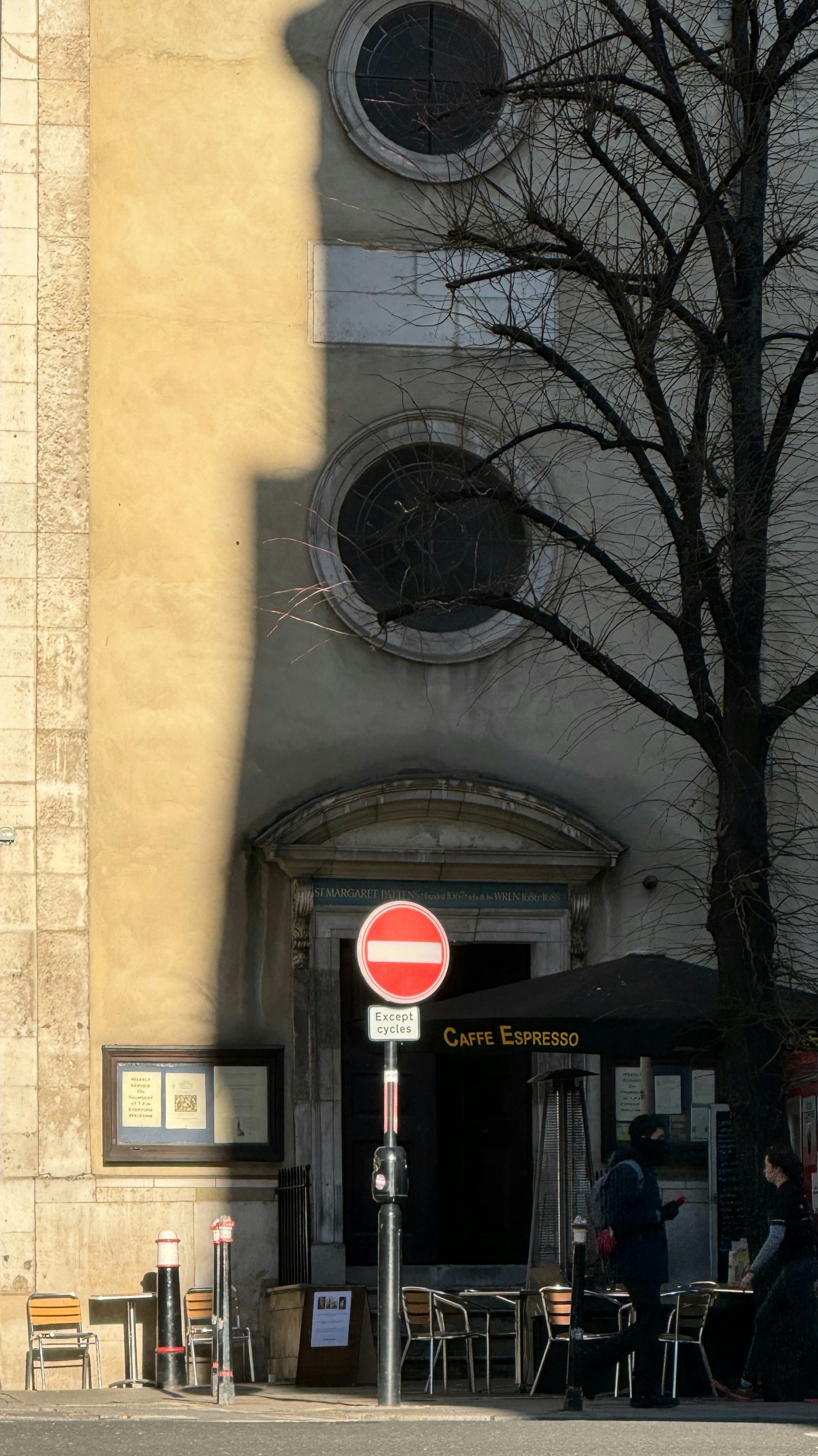 No-Entry Sign Anchors a Sunlit Café Corner