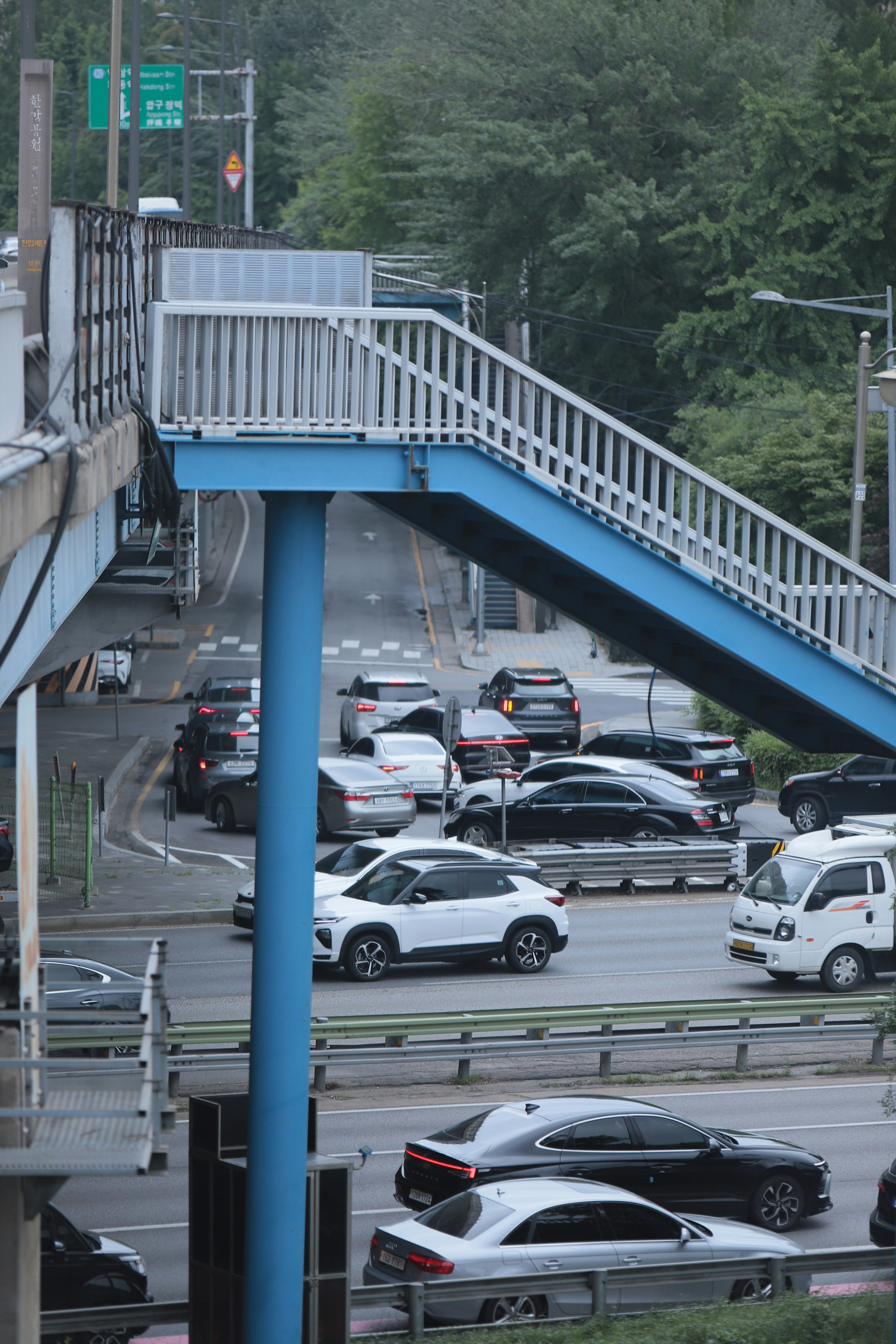 A pedestrian bridge overlooks a busy street of cars. photo – Free Car ...