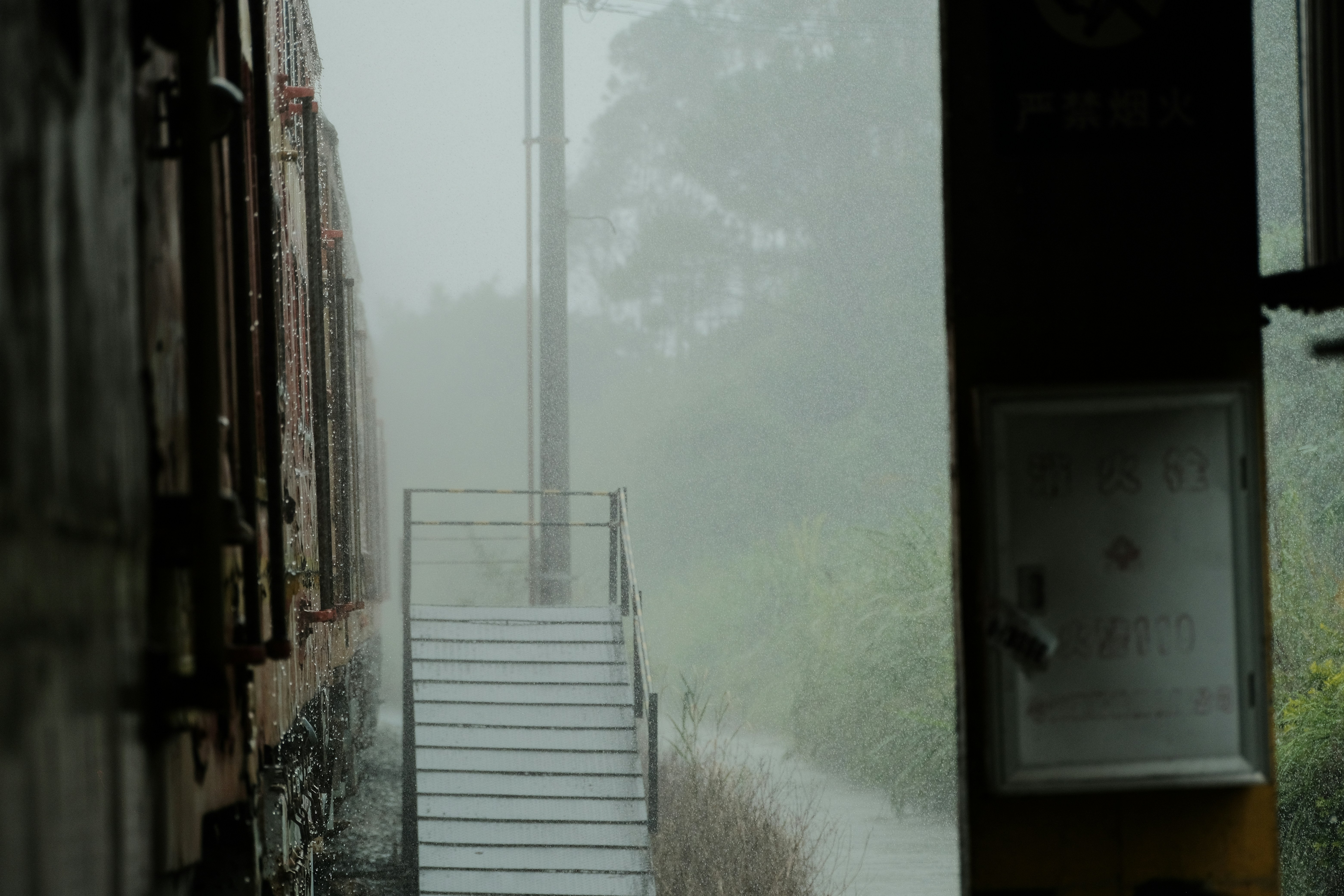 It's a rainy view from inside a train.