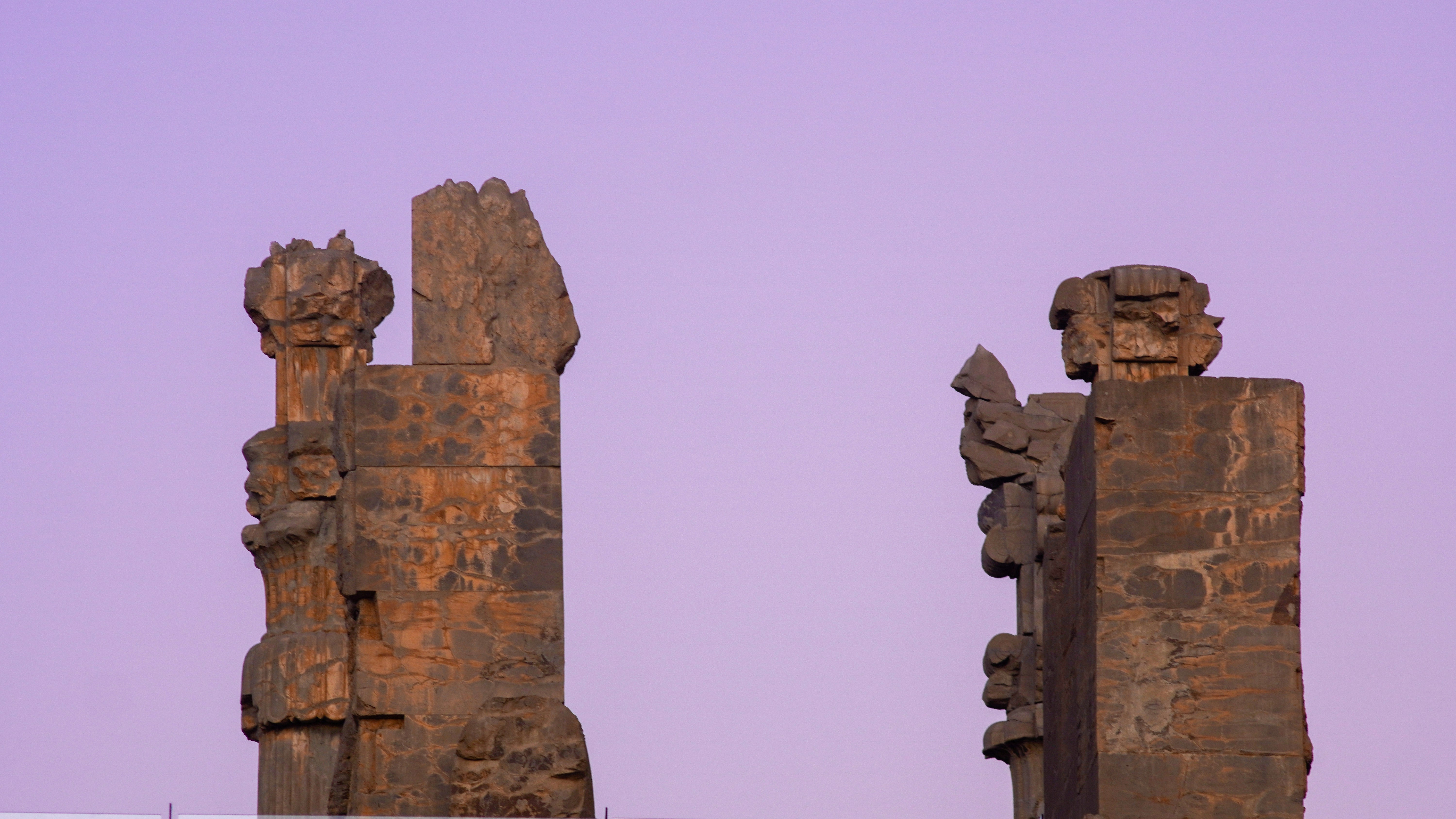 Twin Weathered Monoliths Under a Lavender Sky