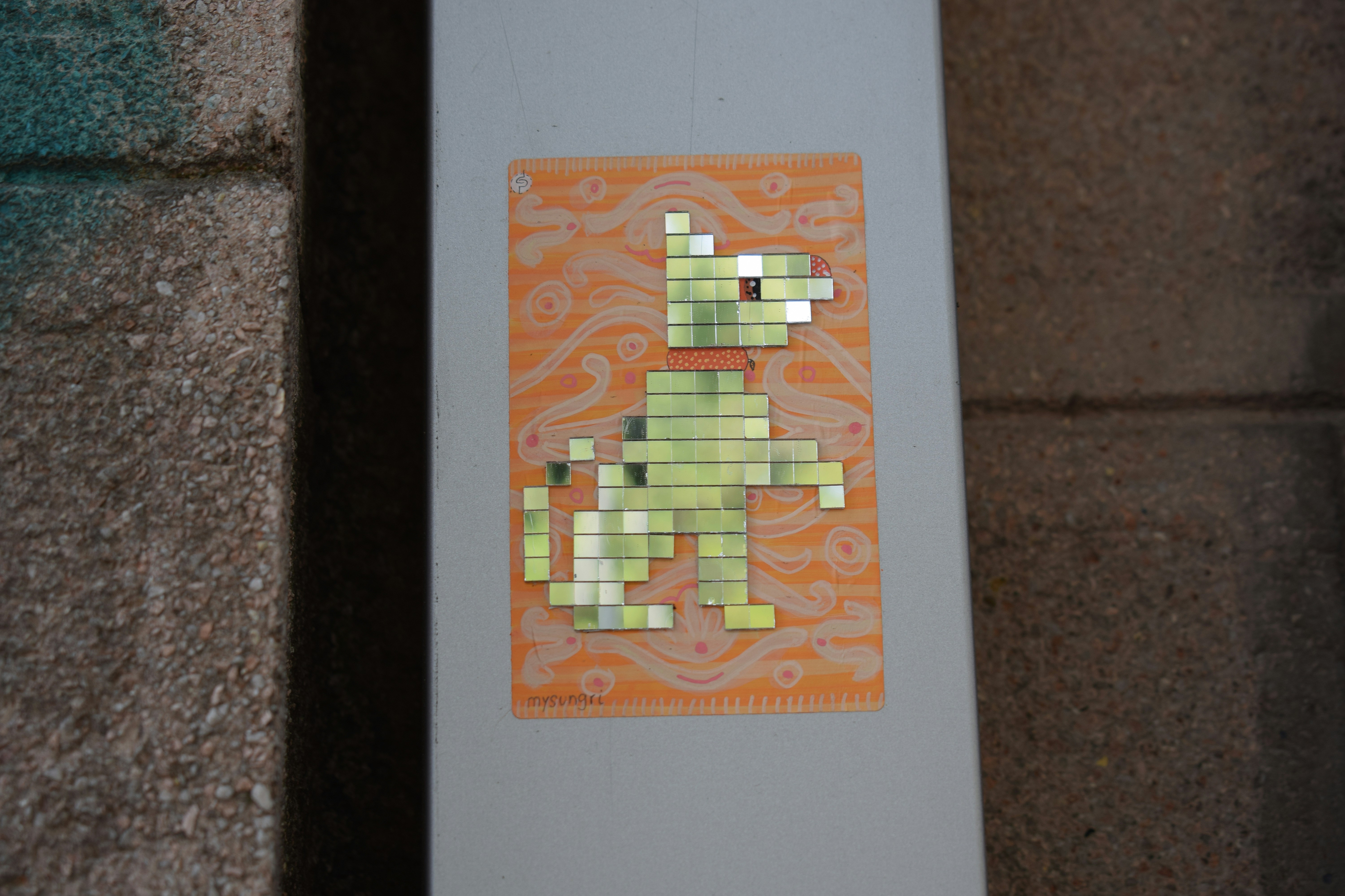 A pixelated reptile is seen on a paper. photo – Free Art Image on Unsplash