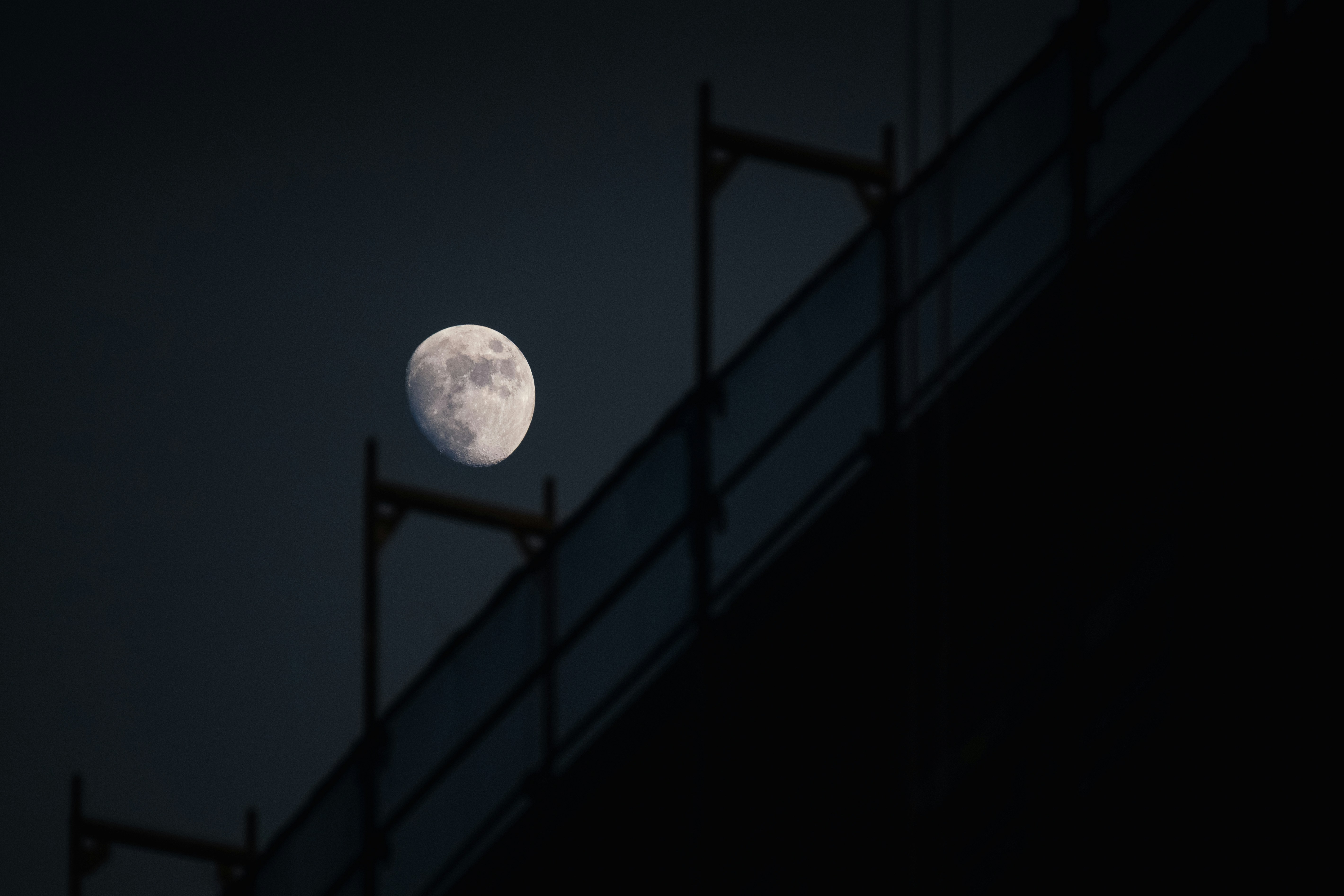 Moonlight on Steel: A Lunar Moment Beneath Silent Scaffolding