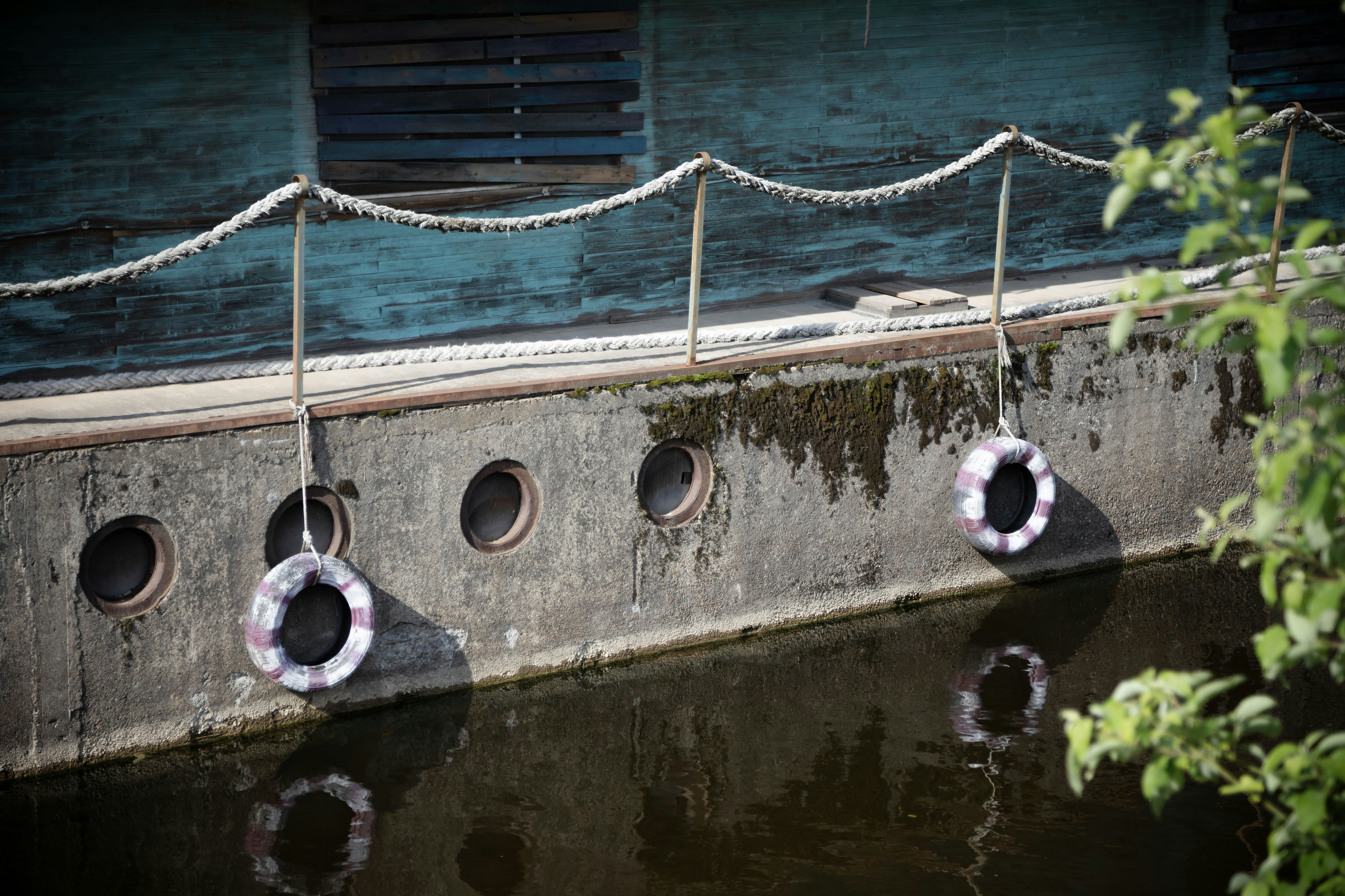 Lifebuoys on a Weathered Wharf: Rings of Color by the Water