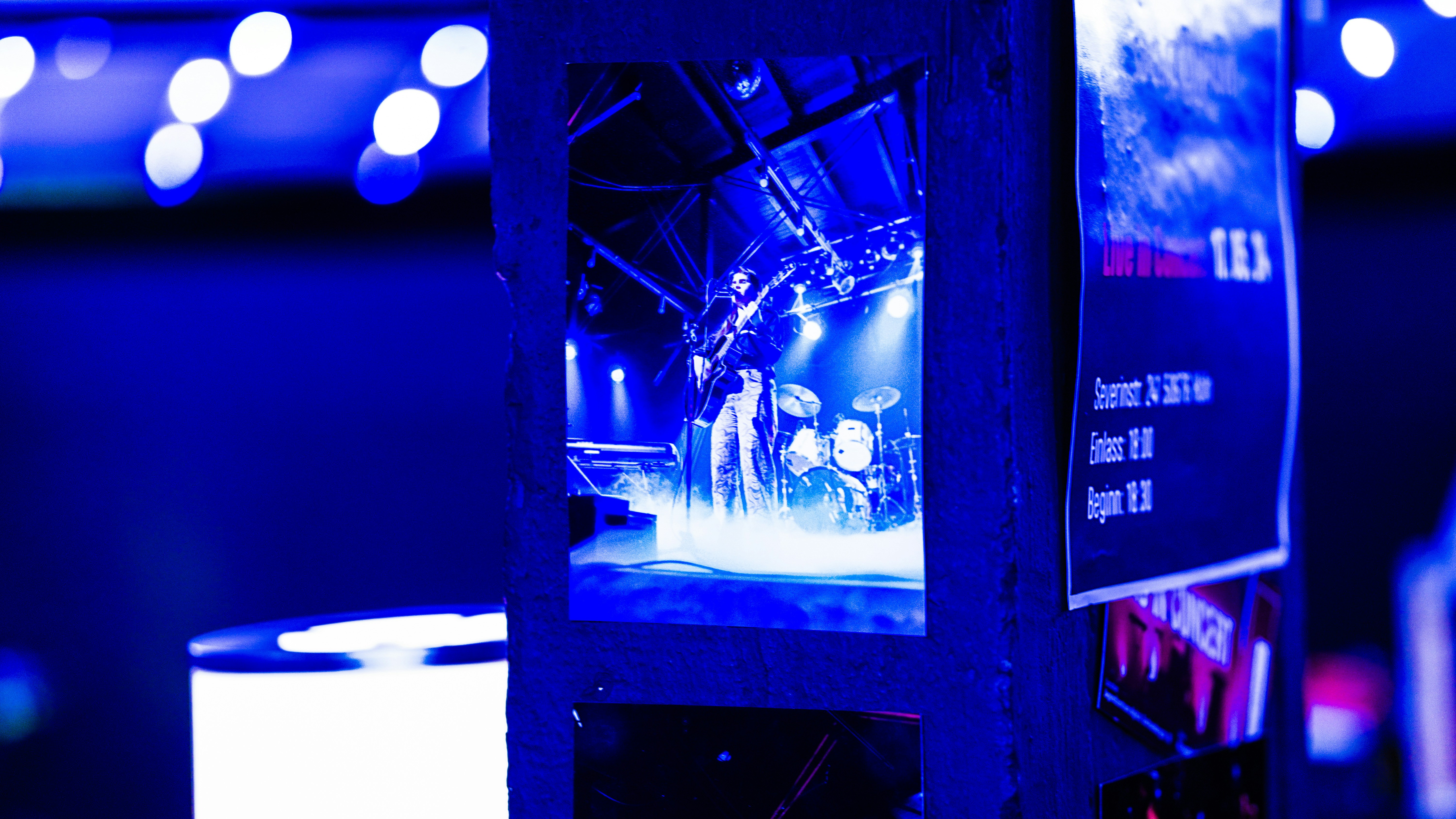 A stage is illuminated with bright blue lights. photo – Free Human ...