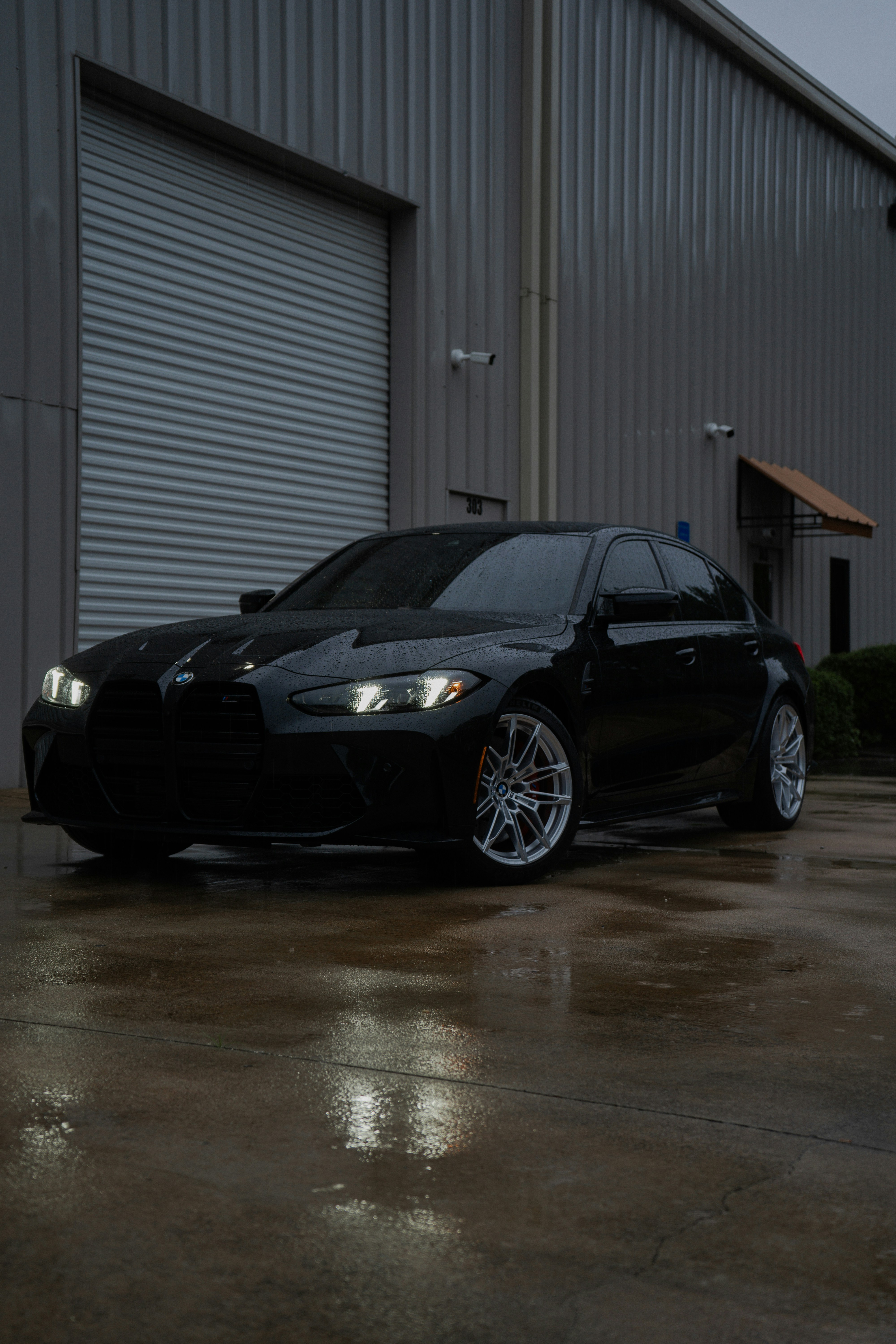 A black BMW sports car is parked outside. photo – Free Car Image on ...