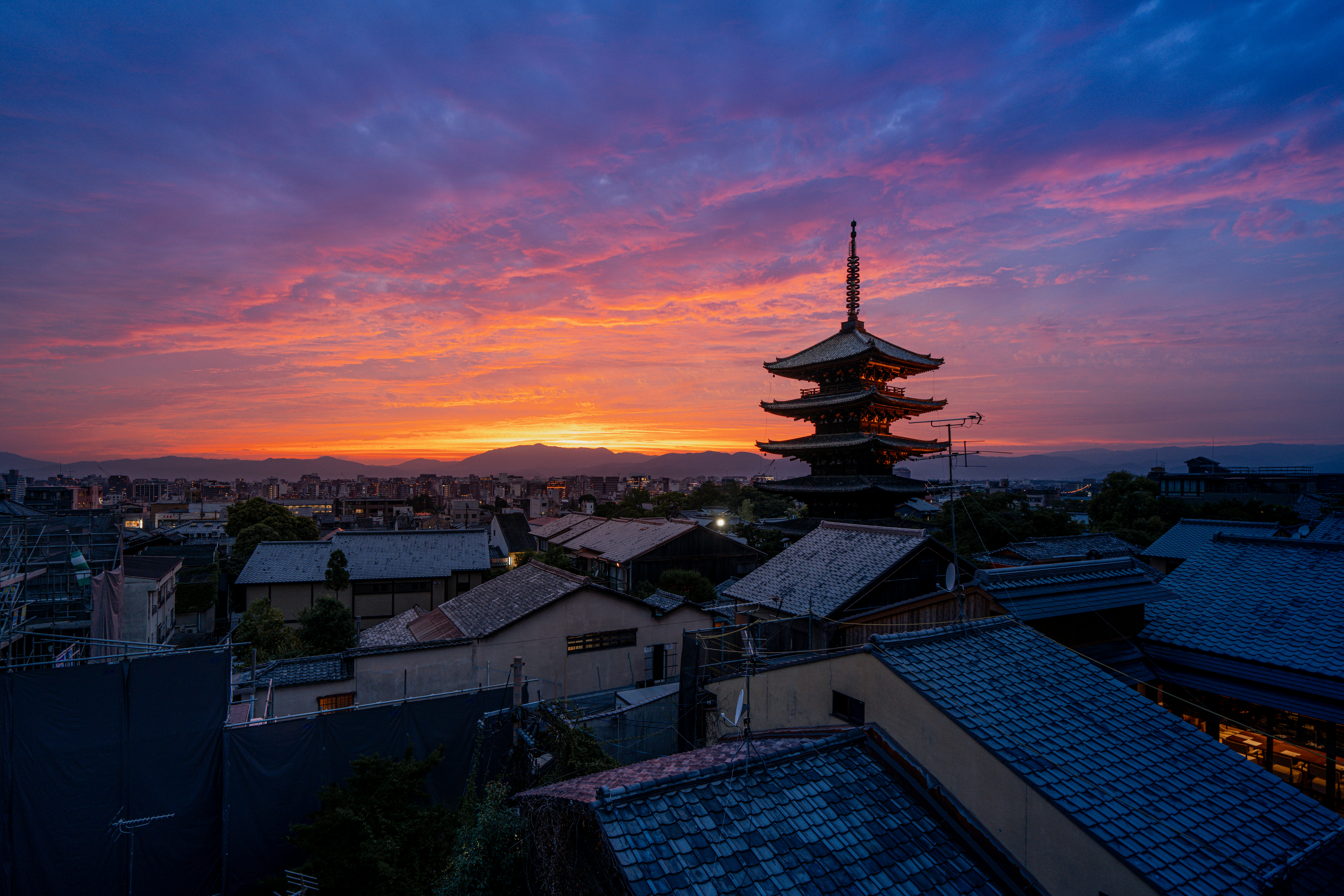 Sunset Over a Traditional Pagoda as Rooftops Whisper the City’s End