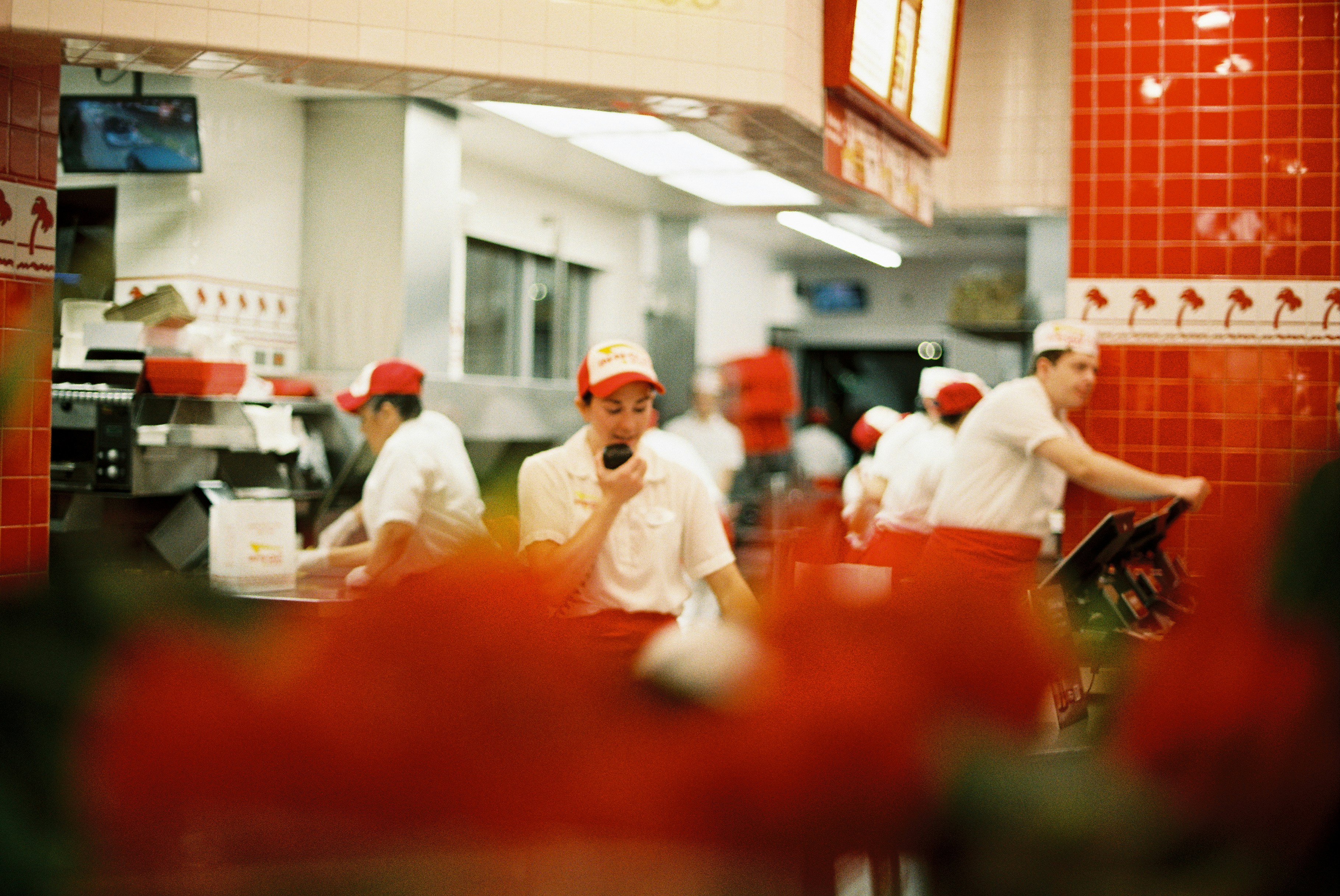 In-n-out workers busy preparing food in the kitchen. photo – Free Film ...