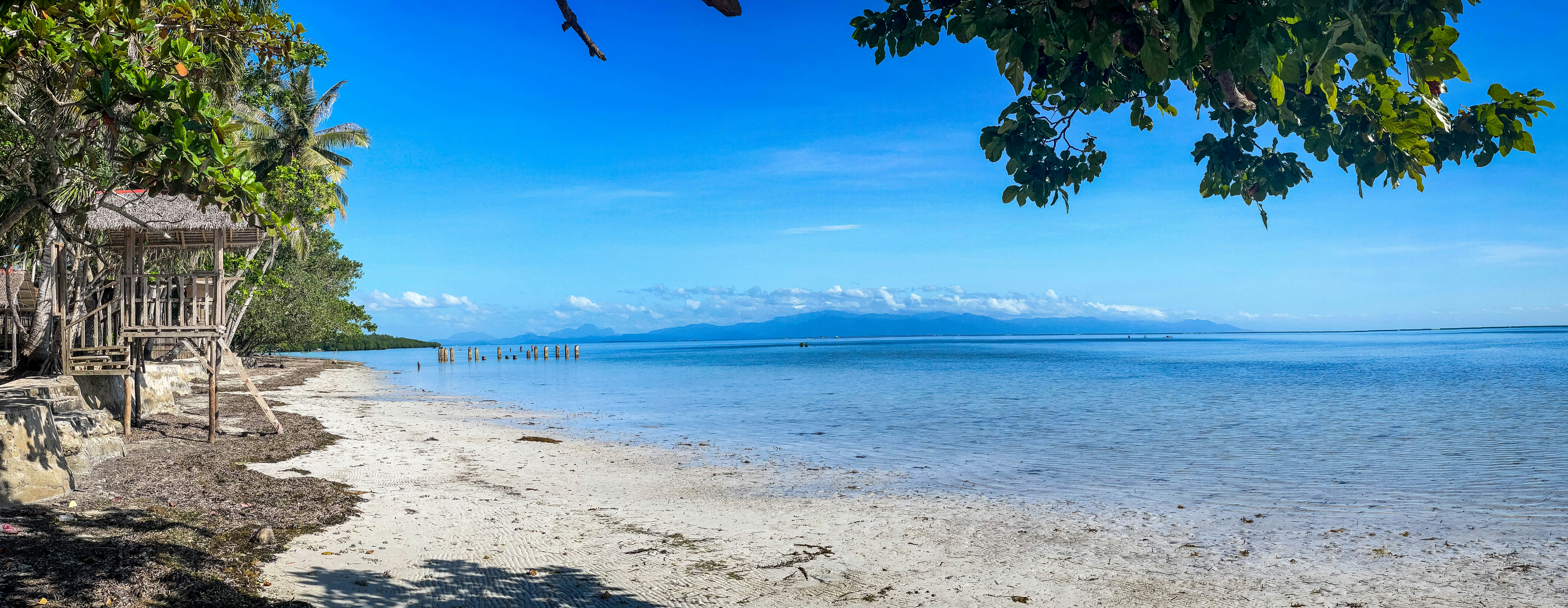 A beautiful beach scene under a bright blue sky. photo – Free Beach ...