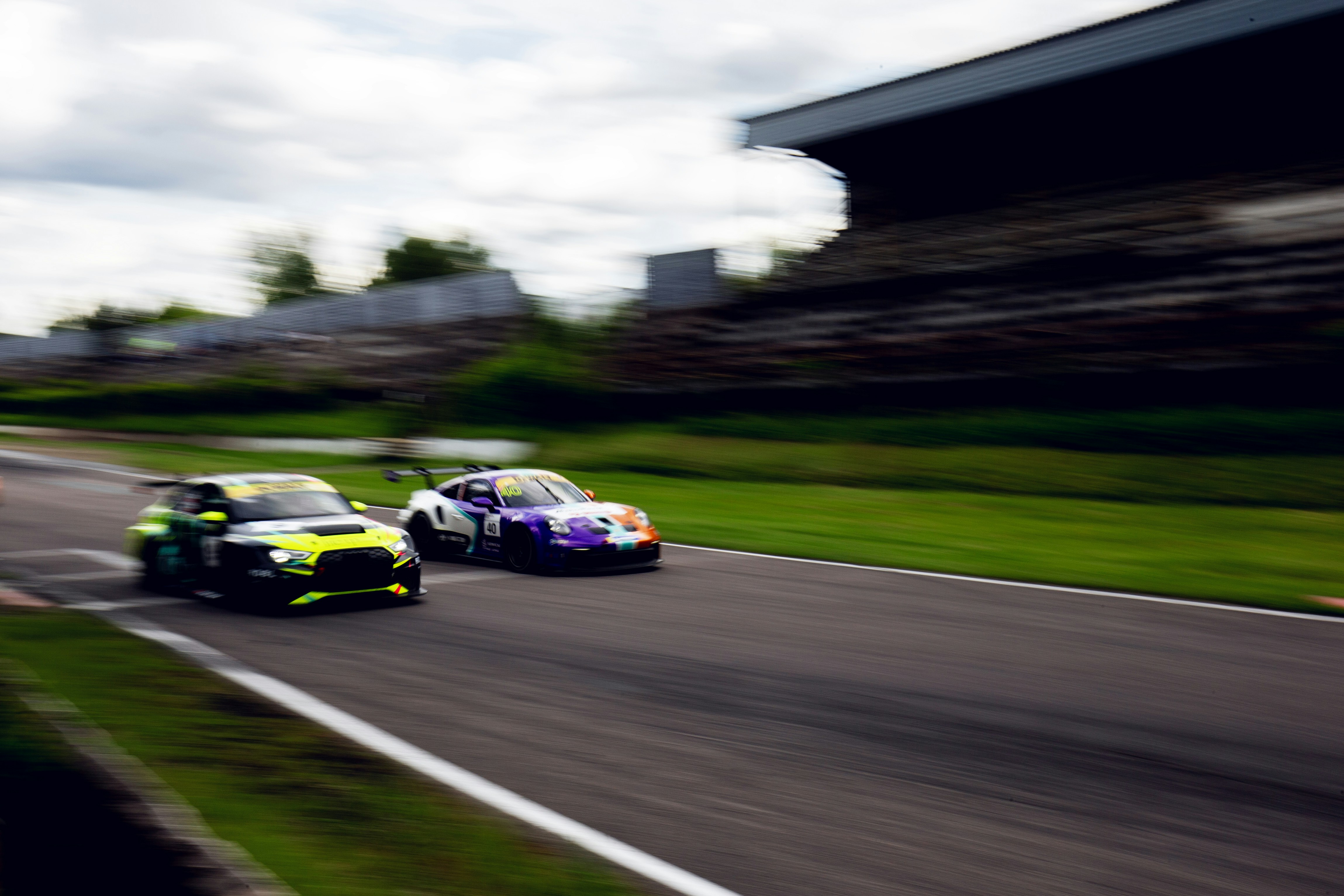 Lead Yellow Car in a High-Speed Blur Around a Narrow Circuit