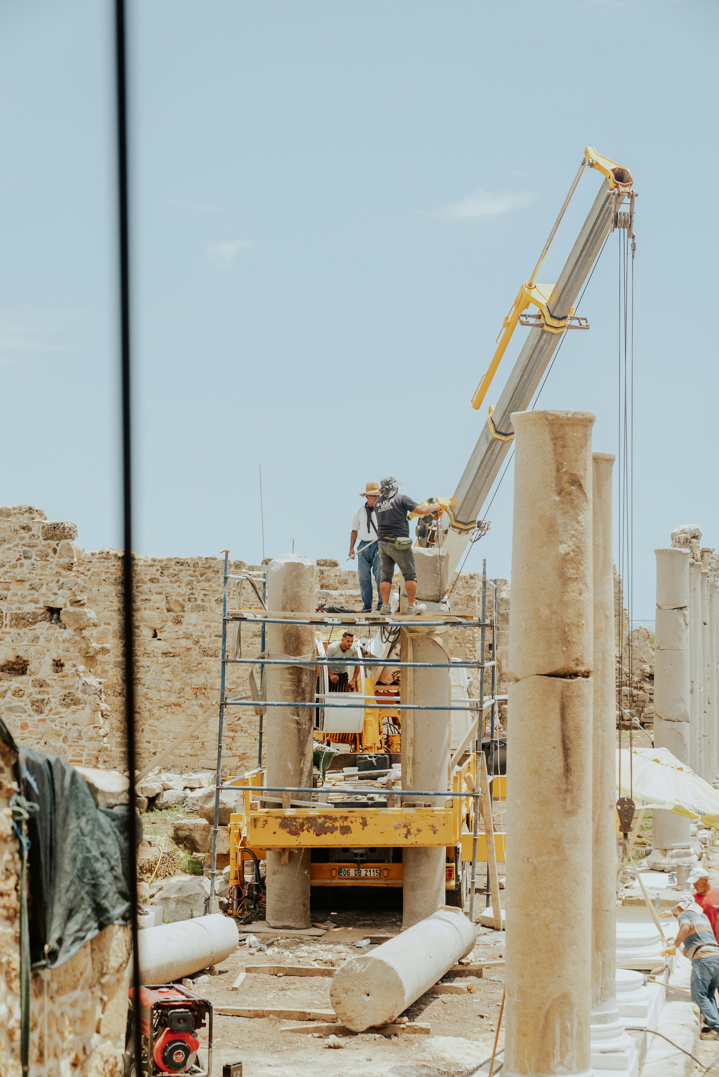 Raising Time: Crane Over Ancient Columns in Active Restoration