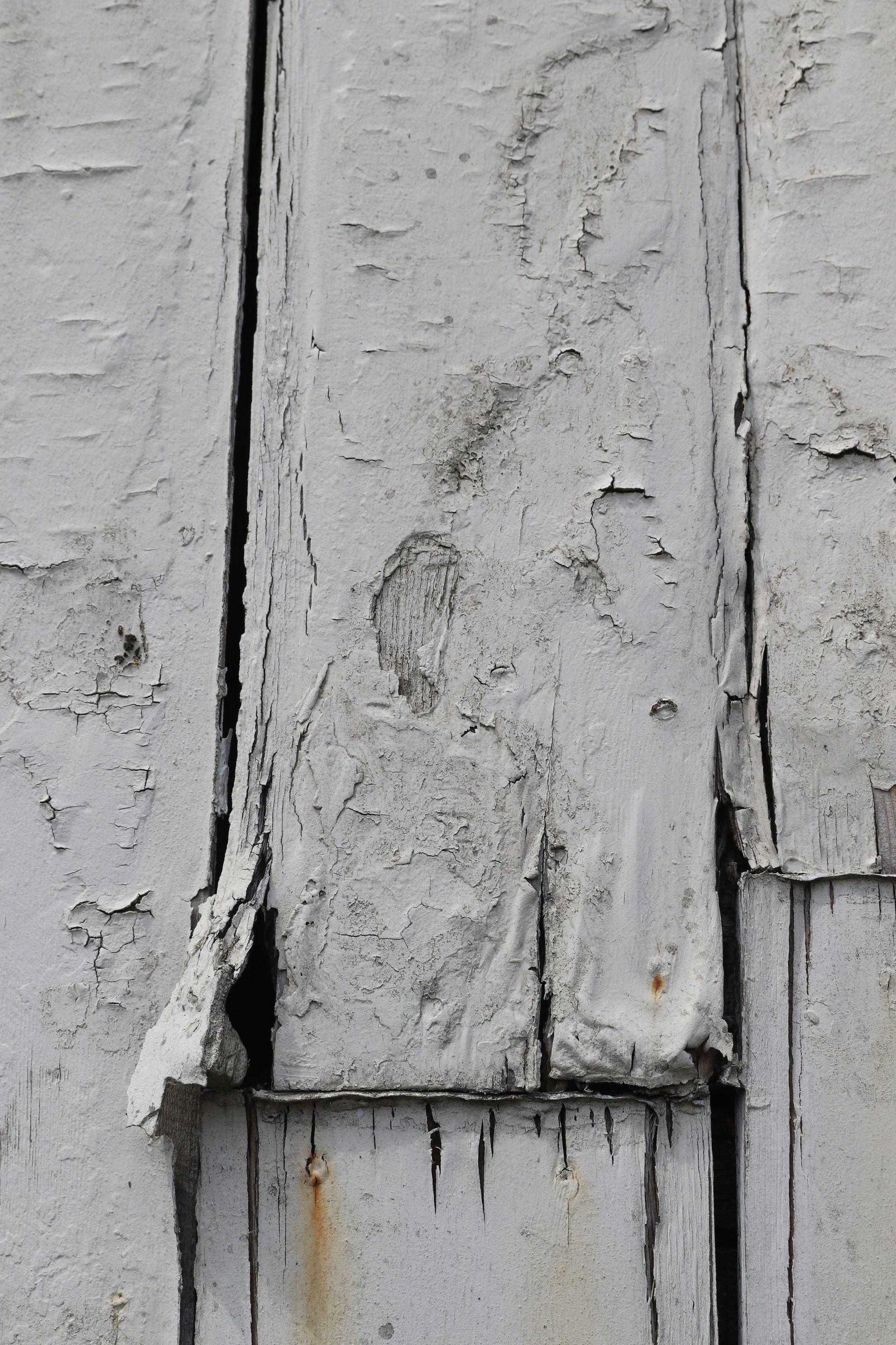 Weathered Layers: Cracked Paint and Rust on Quiet Wooden Planks