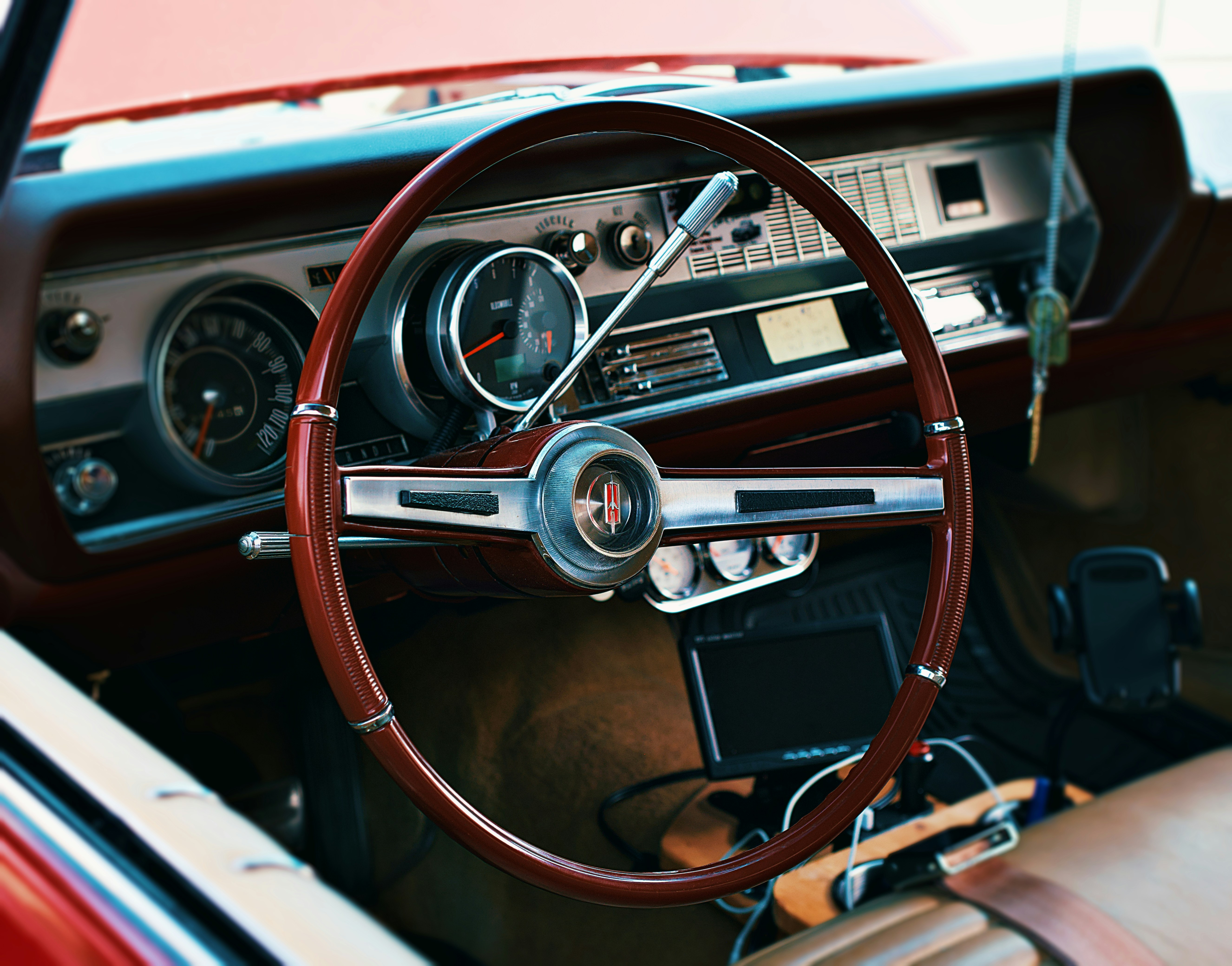 Red vintage classic Lincoln car with silver and red steering wheel.