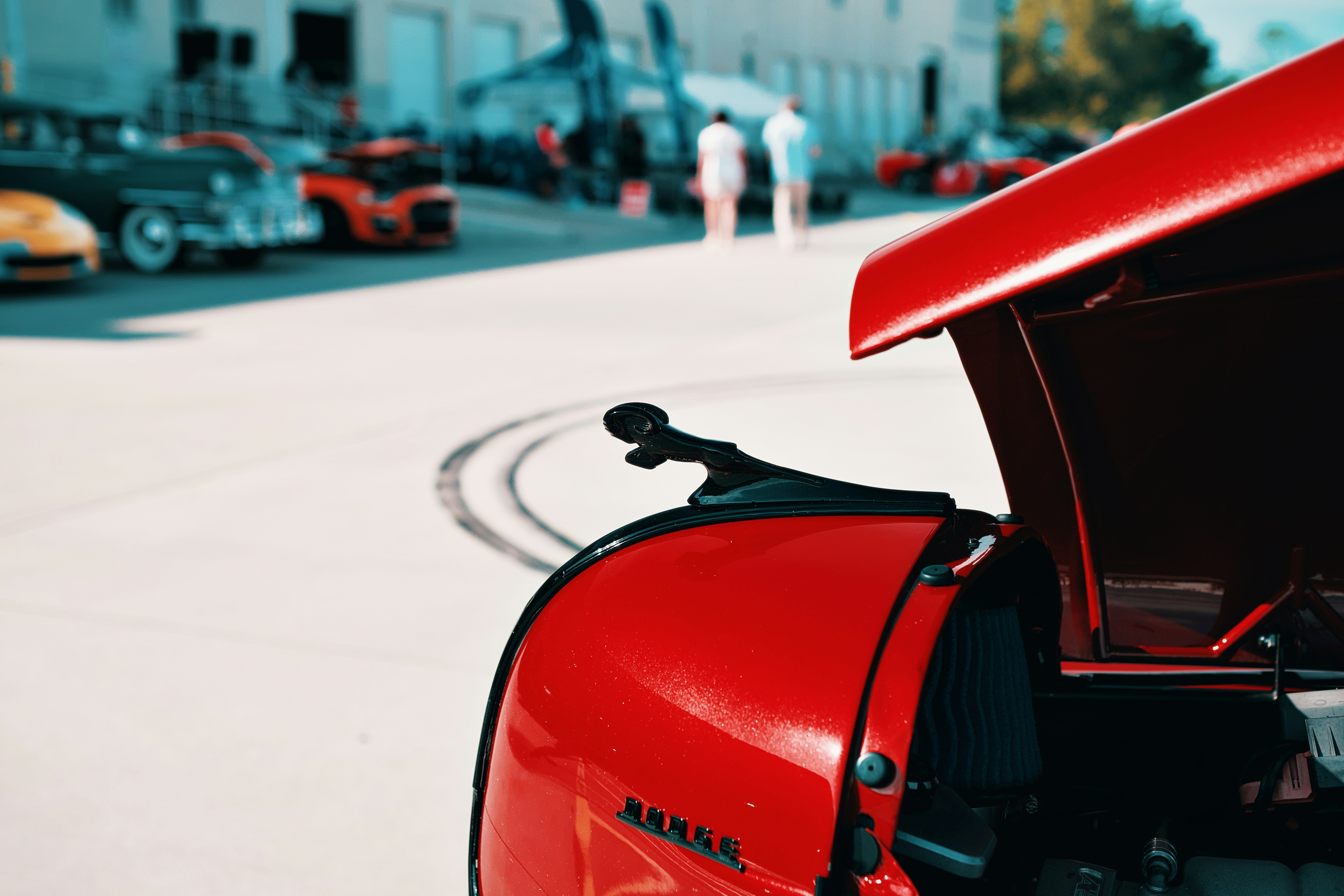 Crimson Bonnet in Focus: A Vintage Red Car Under Crisp Daylight