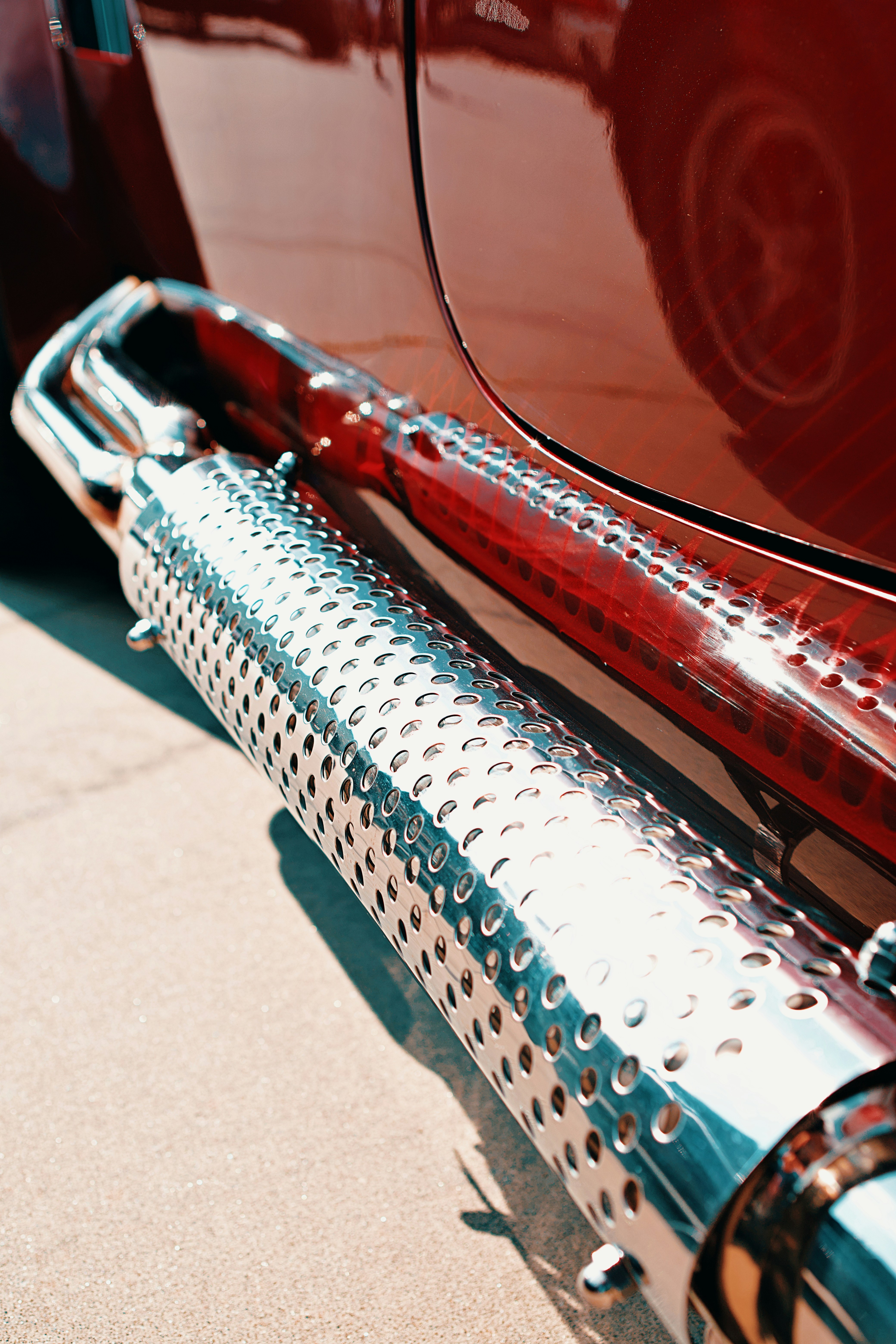 Polished Perforation: chrome side pipe running along a glossy red ride
