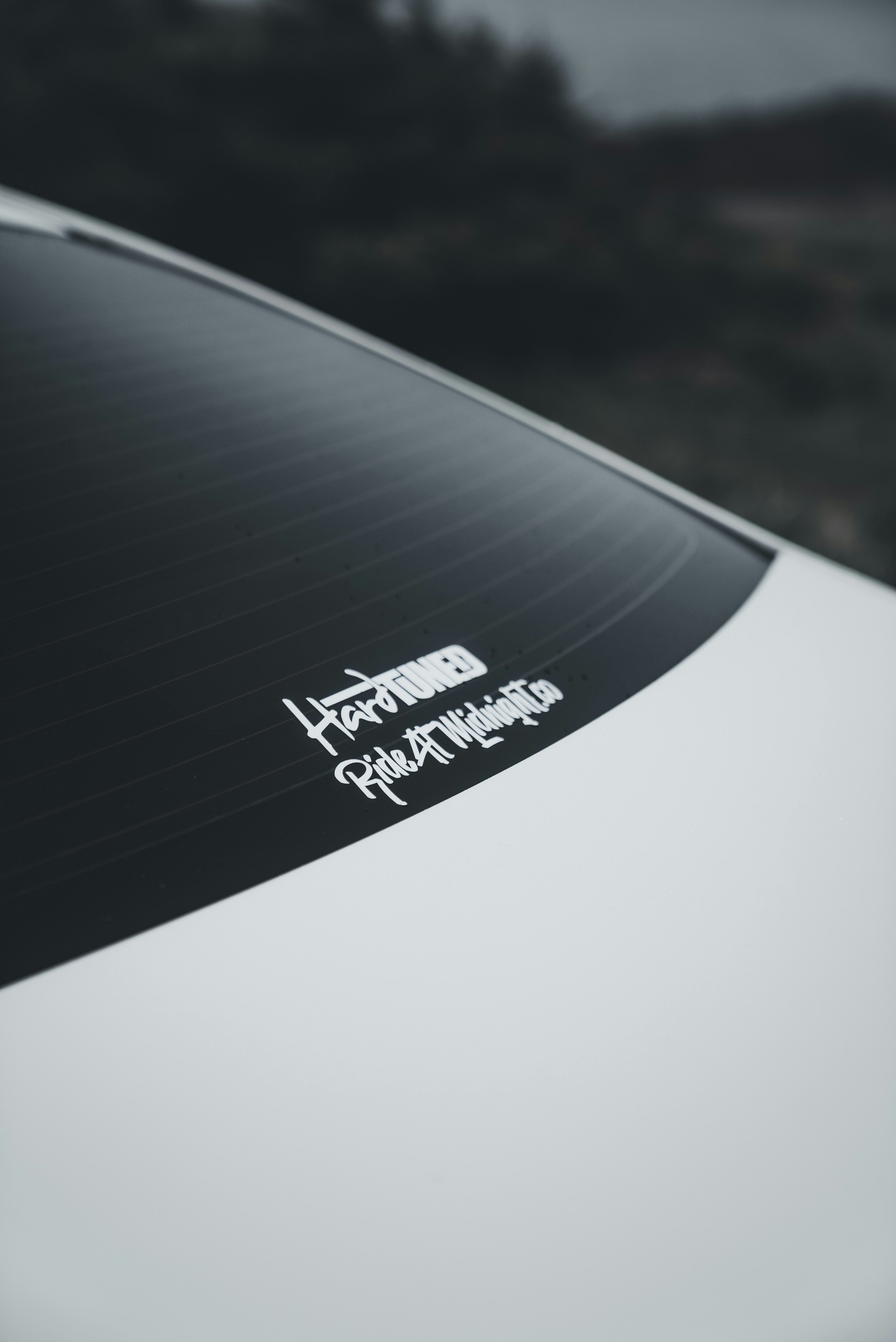 A car window with a "happy tuned" sticker. photo – Free Car Image on ...