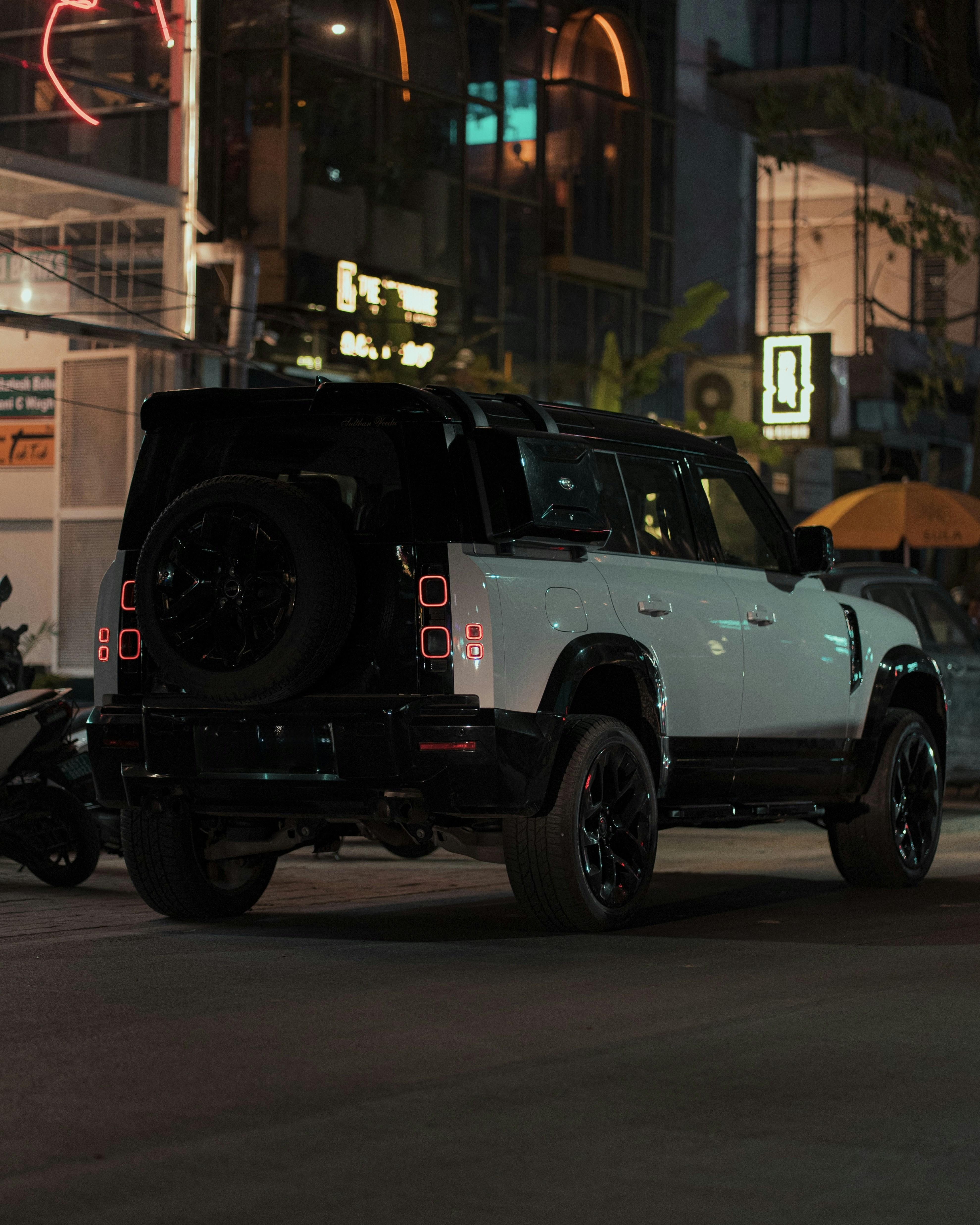 A black and white defender parked at night. photo – Free Wallpaper ...